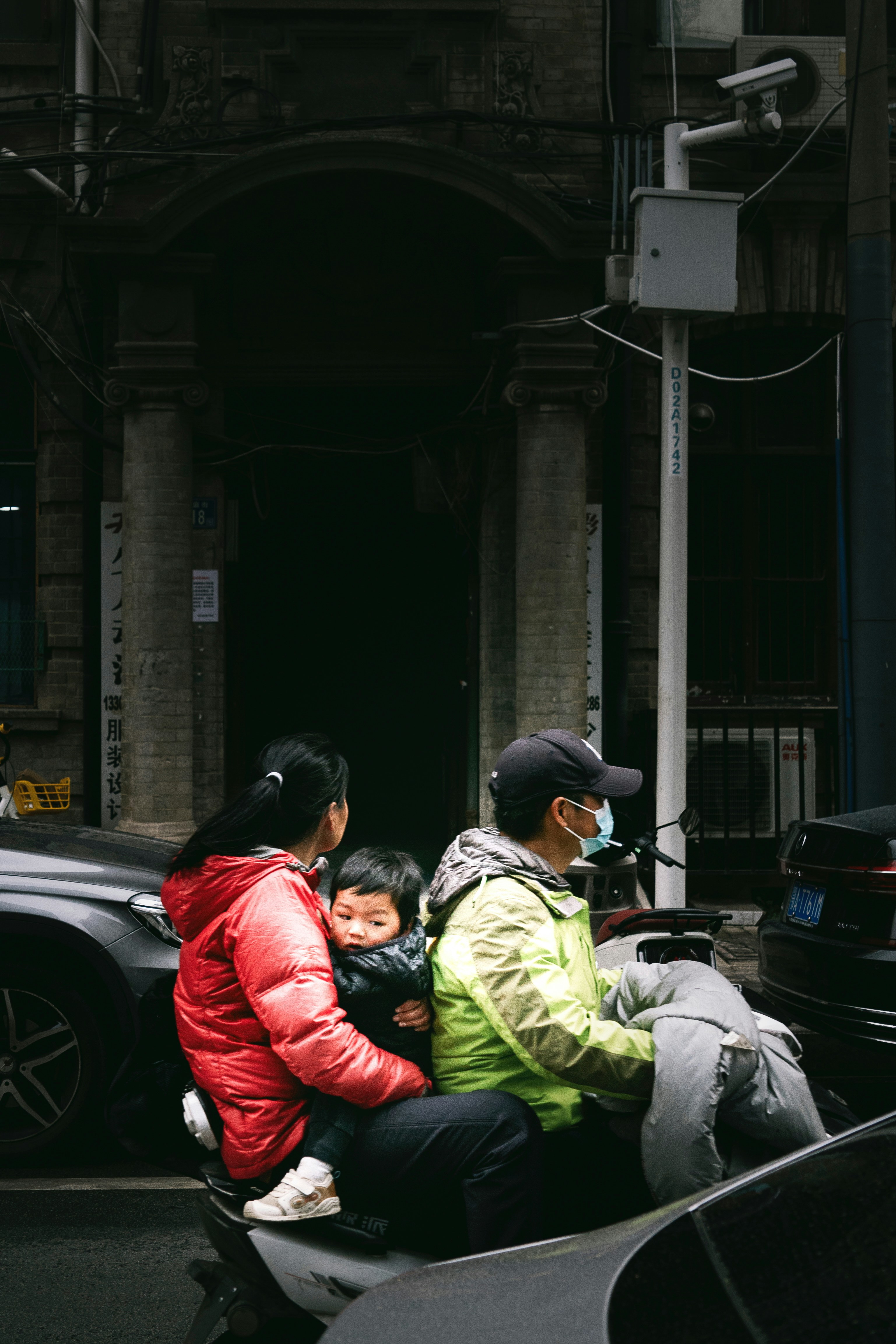 Dusk-Shift Duo: A Family Rides Through a Quiet City Block