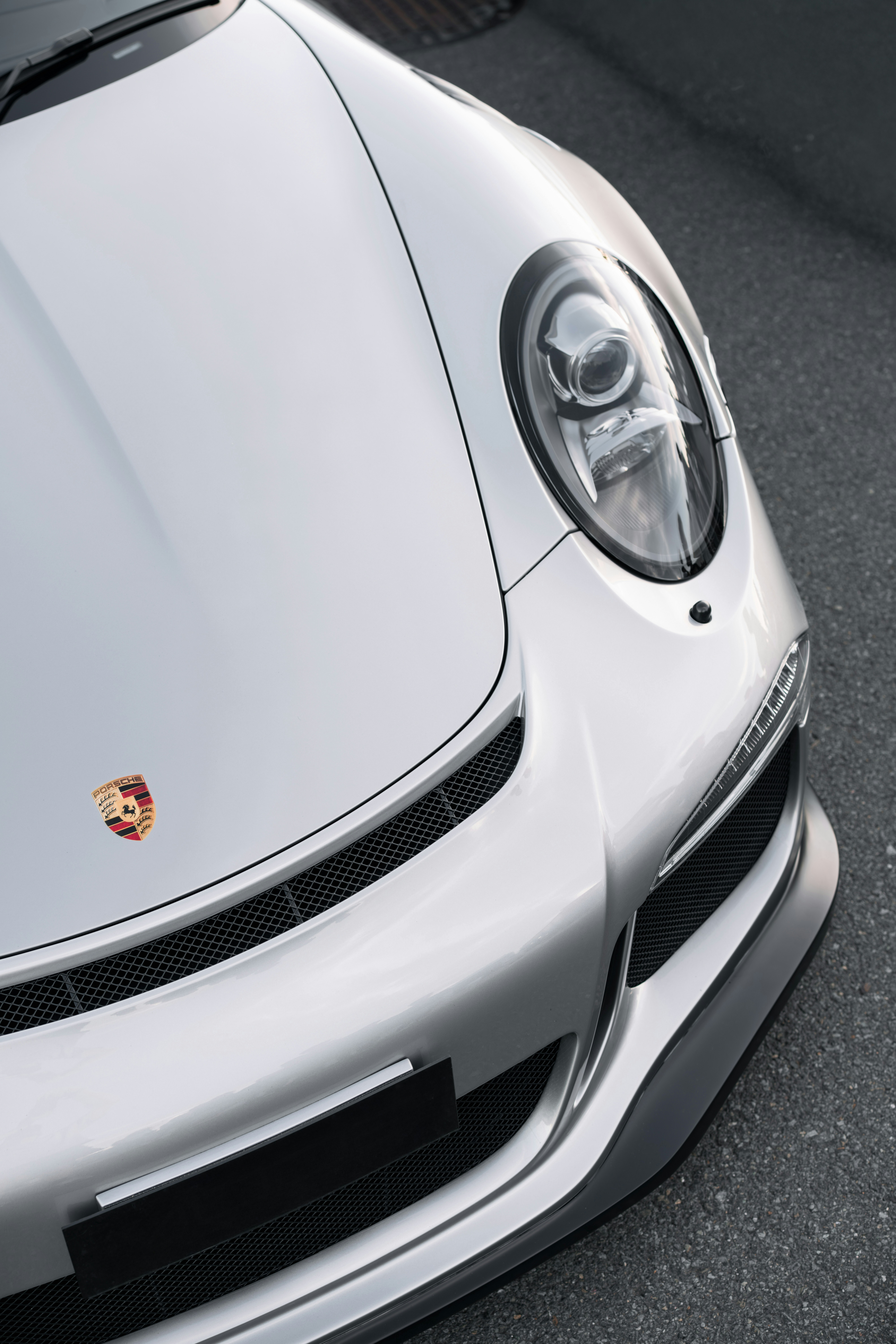 Porsche Front-Quarter Portrait: White Curves and Crest