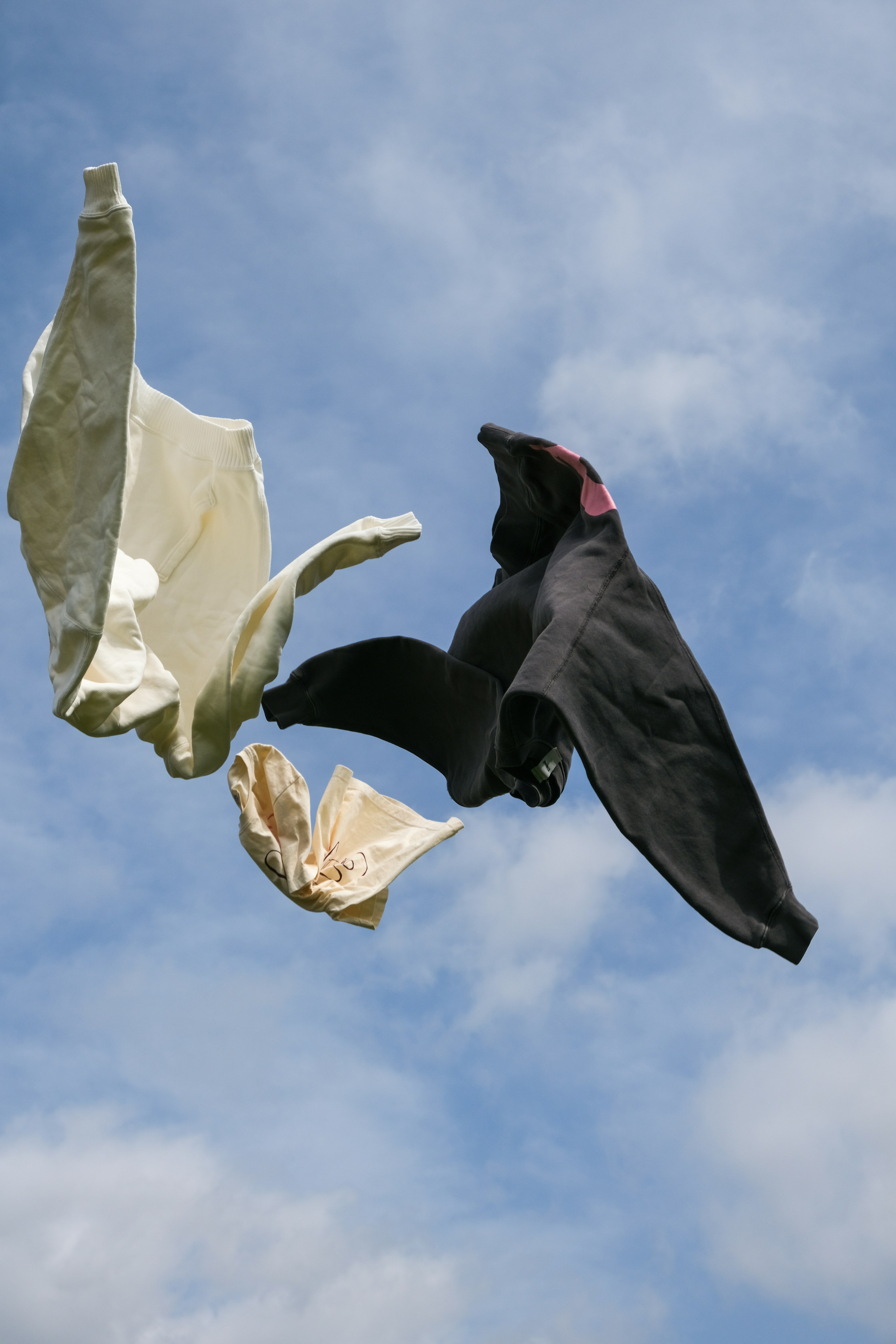 Clothes blow in the wind against a blue sky. photo – Free Fashion Image ...
