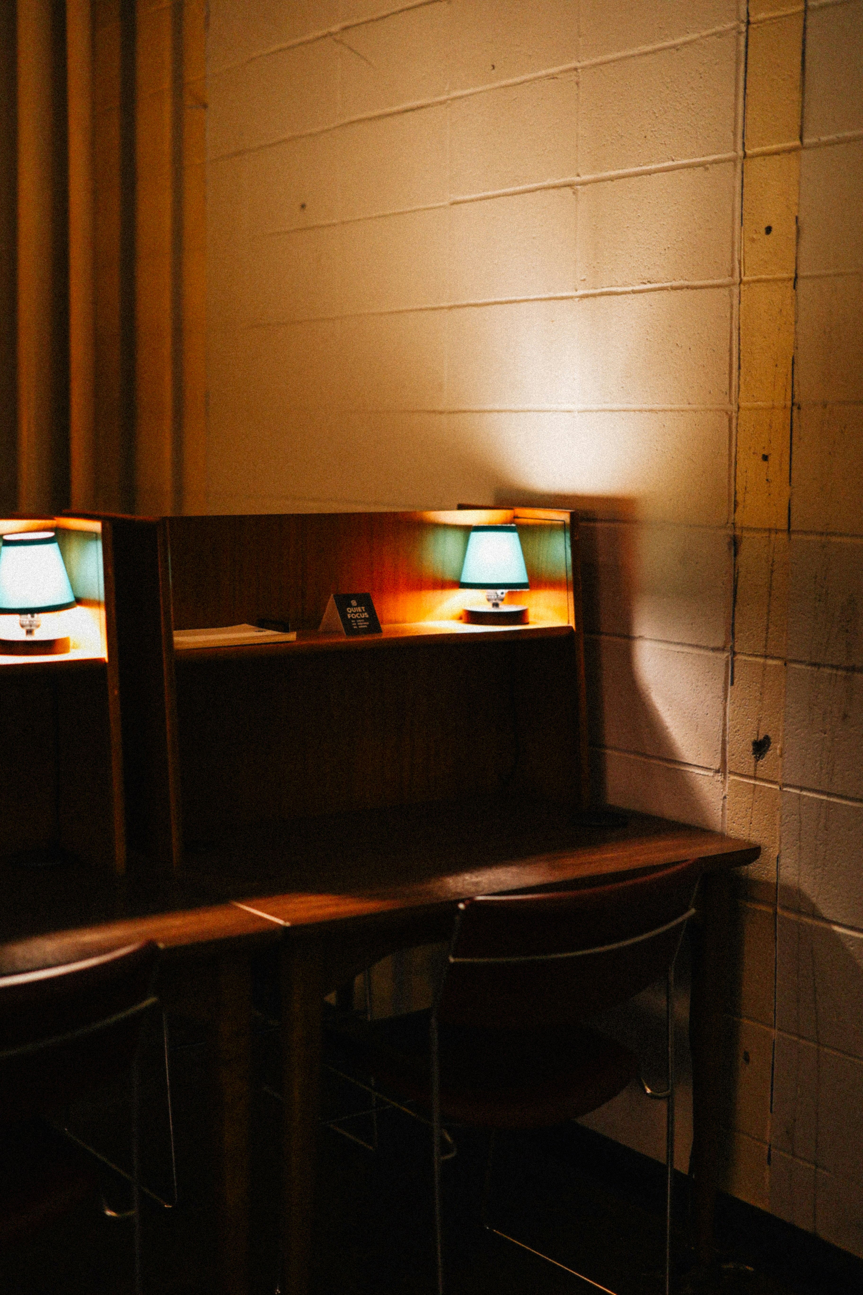 Desks with lamps are in a dimly lit study area. photo – Free Building ...