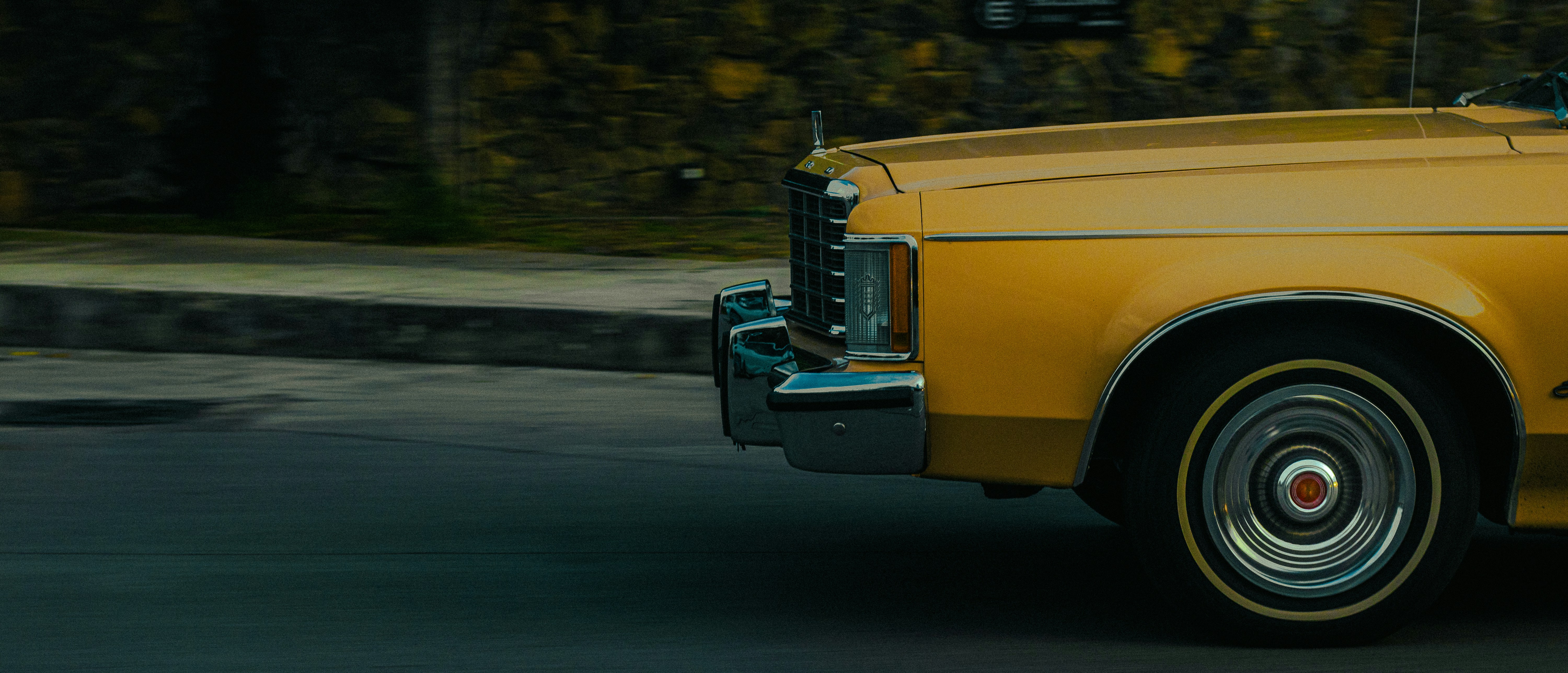 A yellow car drives past on the street. photo – Free Car Image on Unsplash