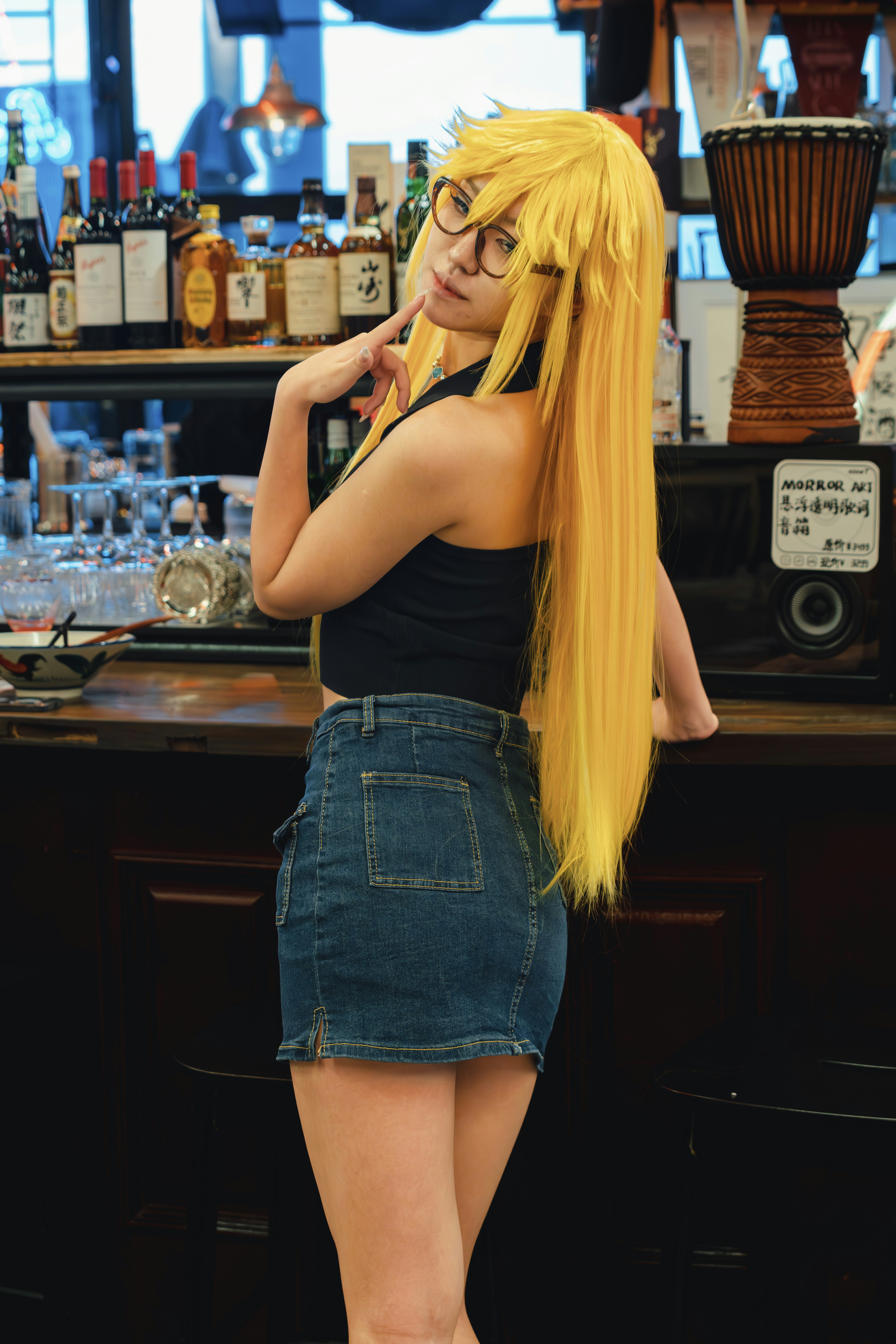 Cosplayer poses at a bar with bright yellow hair. photo – Free Woman ...