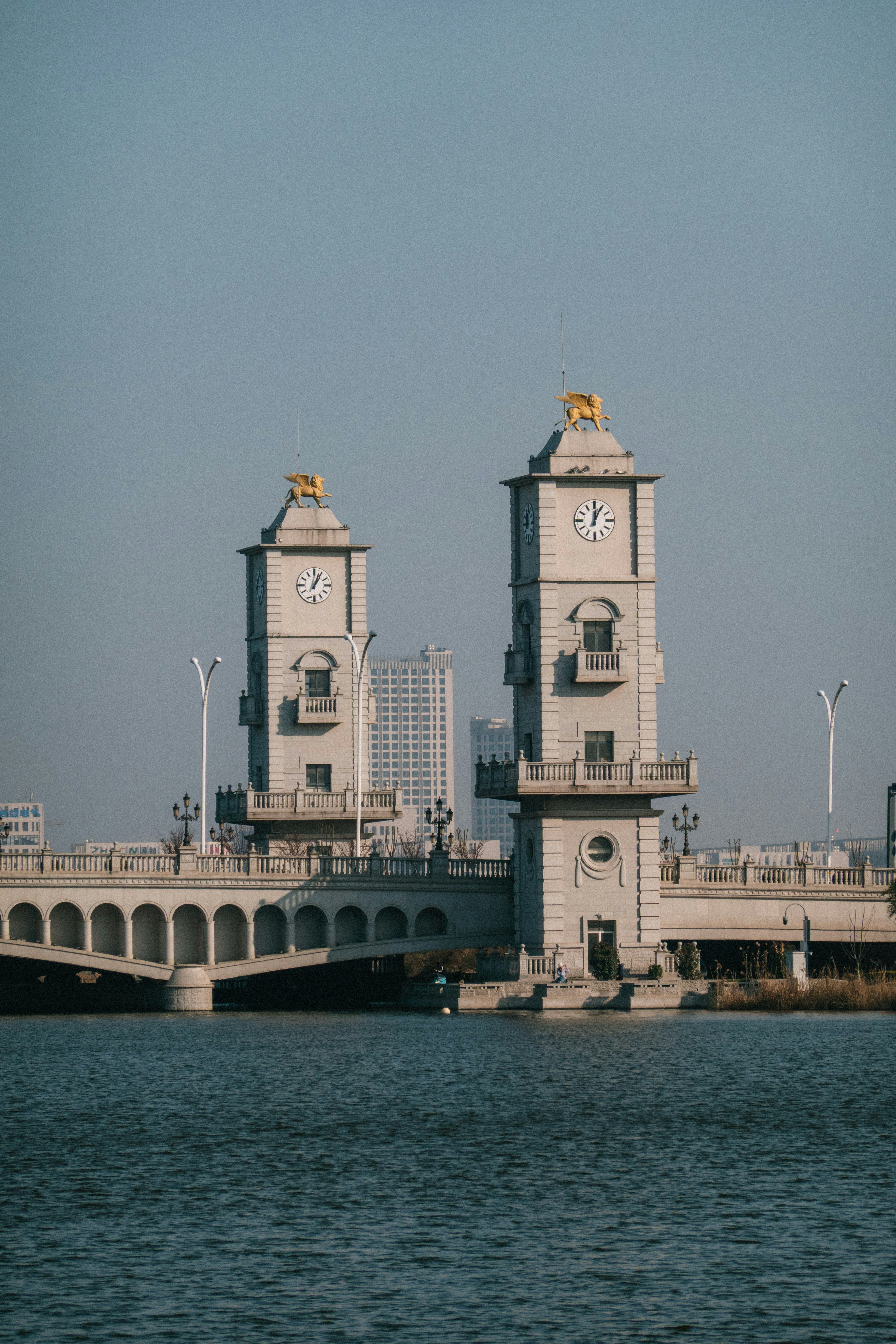 Twin Clock Towers Upon the River: A calm harbor of stone and time