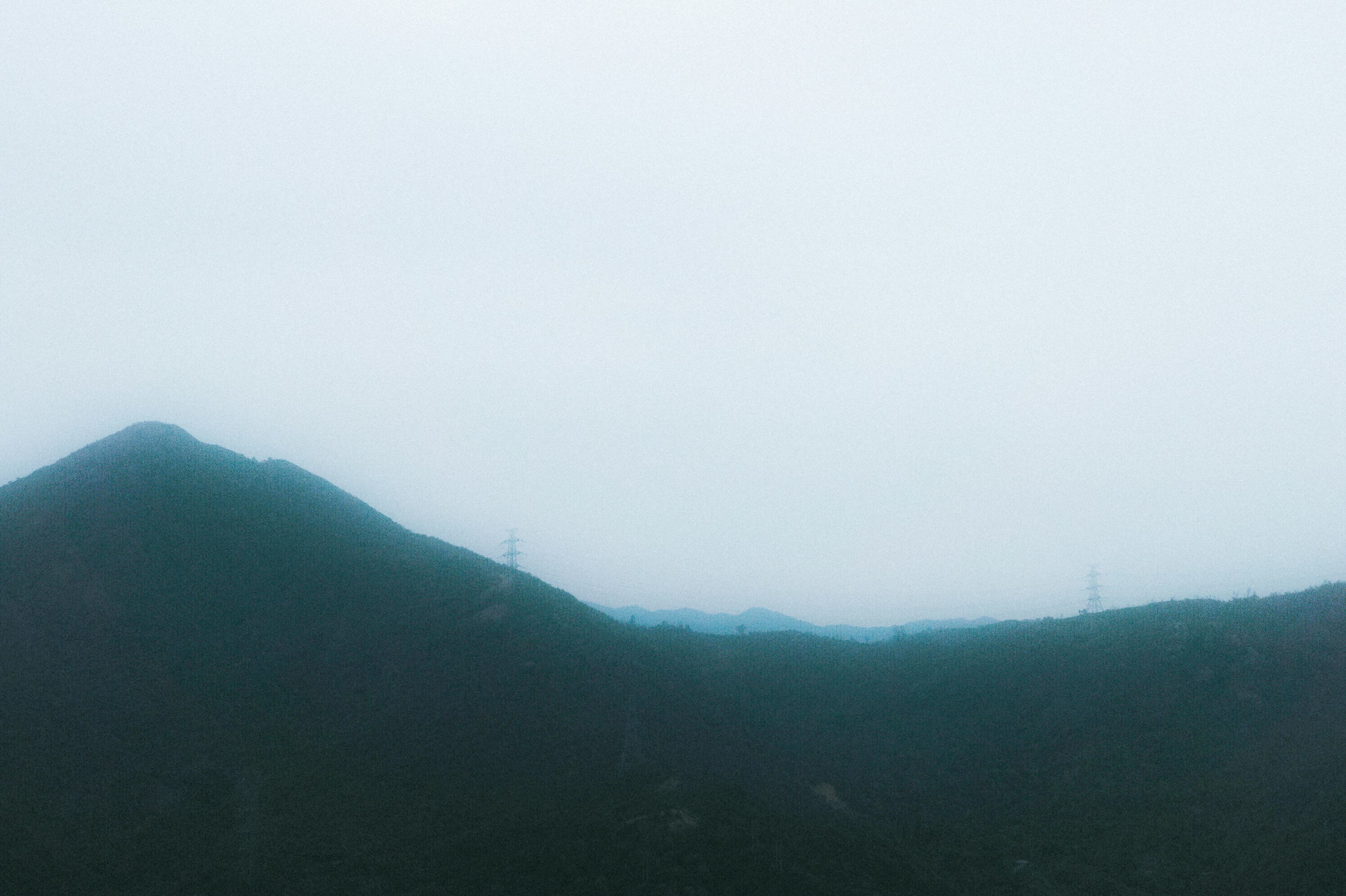 Fog envelops distant hills, creating a serene and soft landscape.