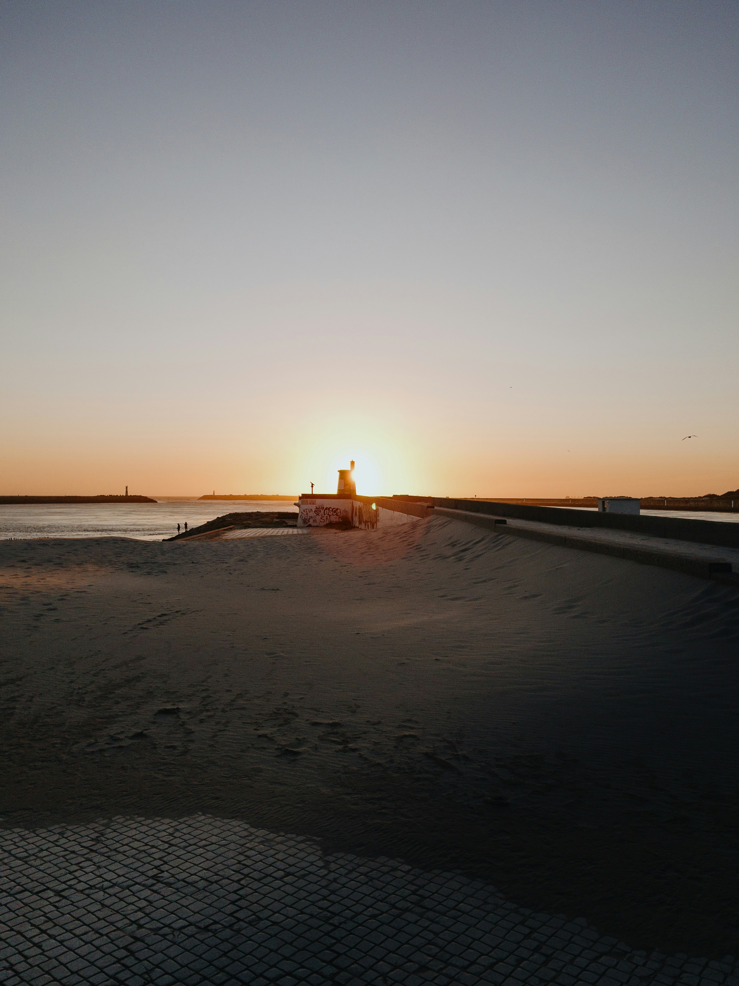 Sunset casts a golden glow over the coastline.