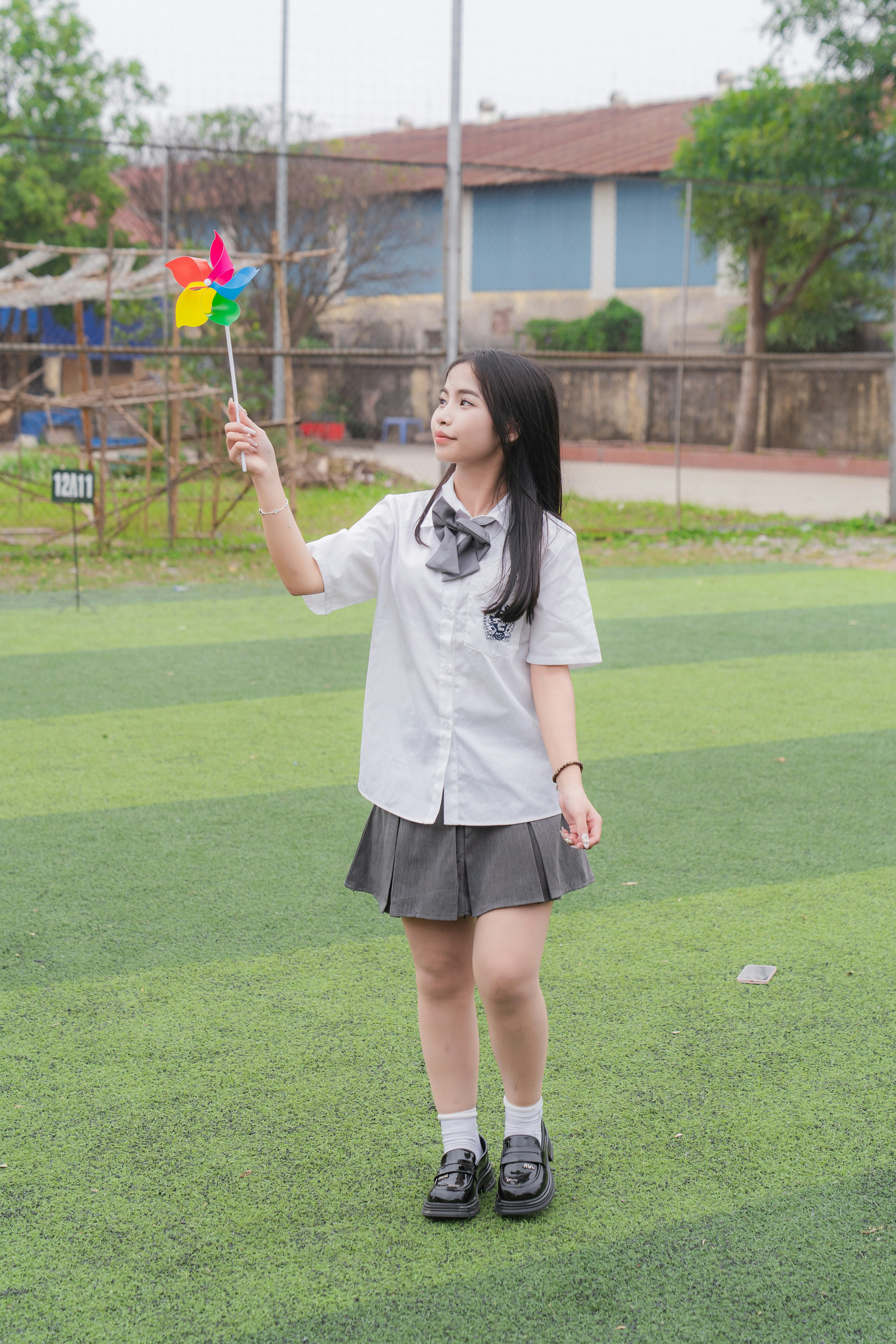 Pinwheel Moment on the Grass: A Schoolgirl in Color