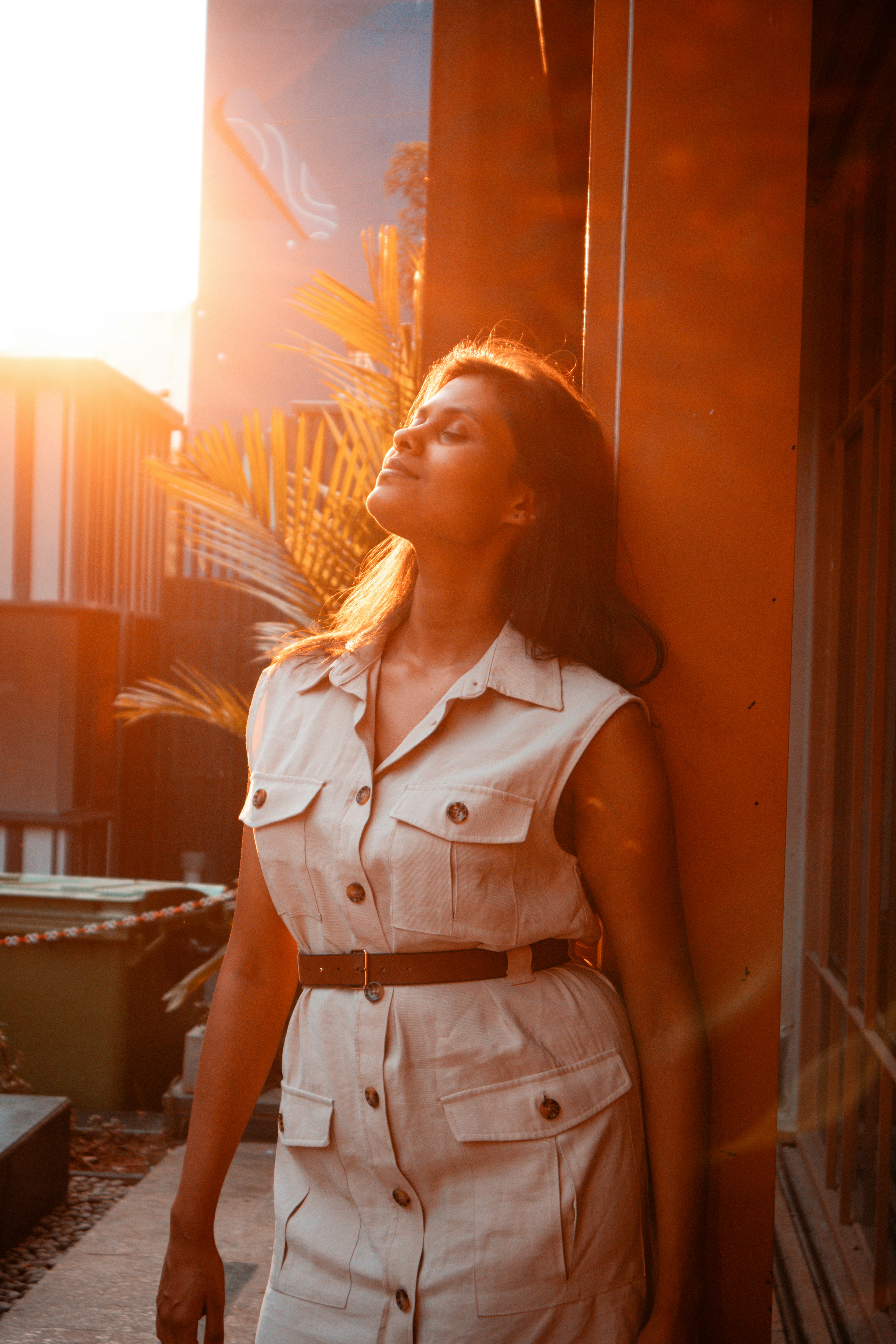 Emberlight Portrait: Woman Leaning Into the Sunlit Corridor