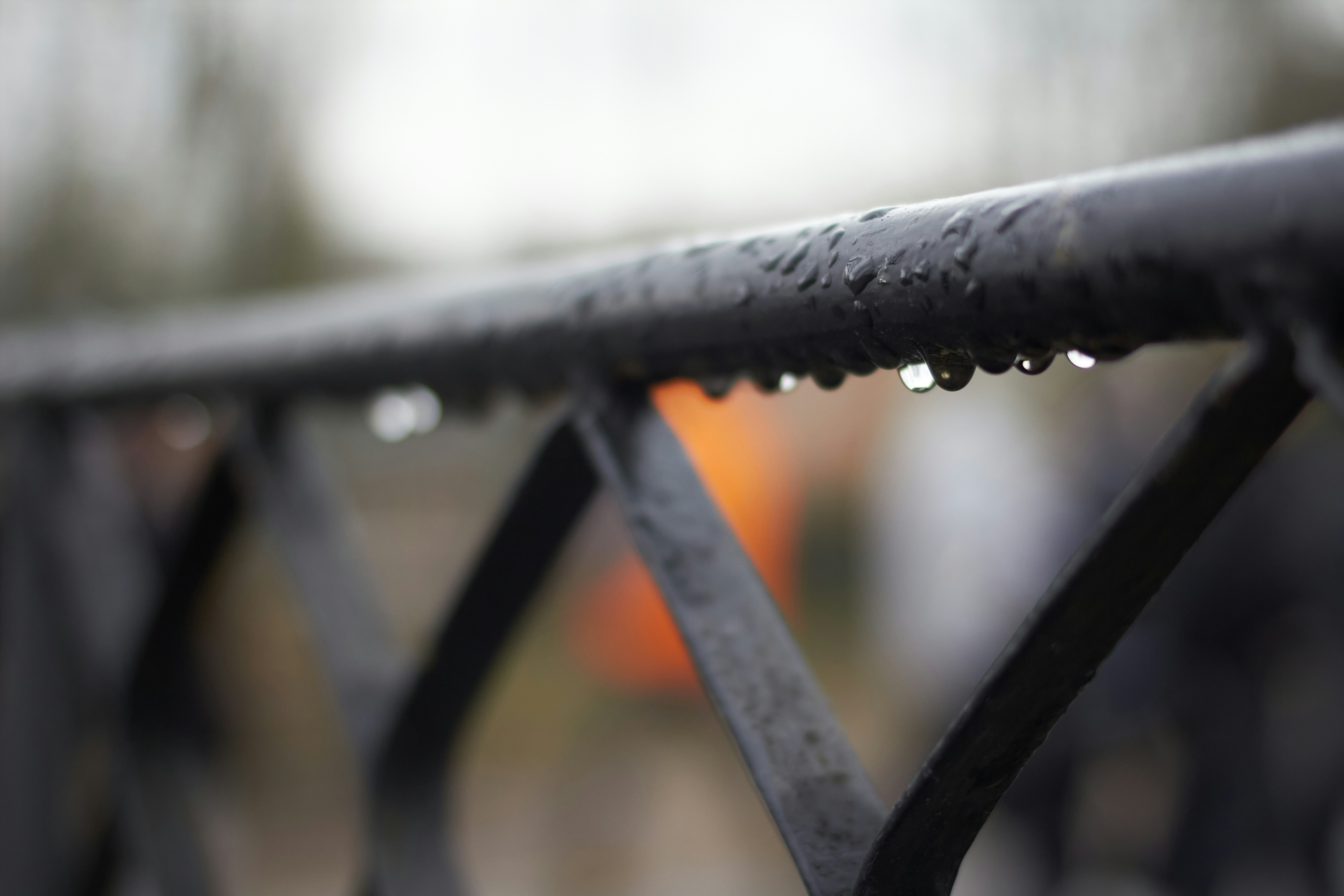 Raindrops on a metal railing: a quiet close-up