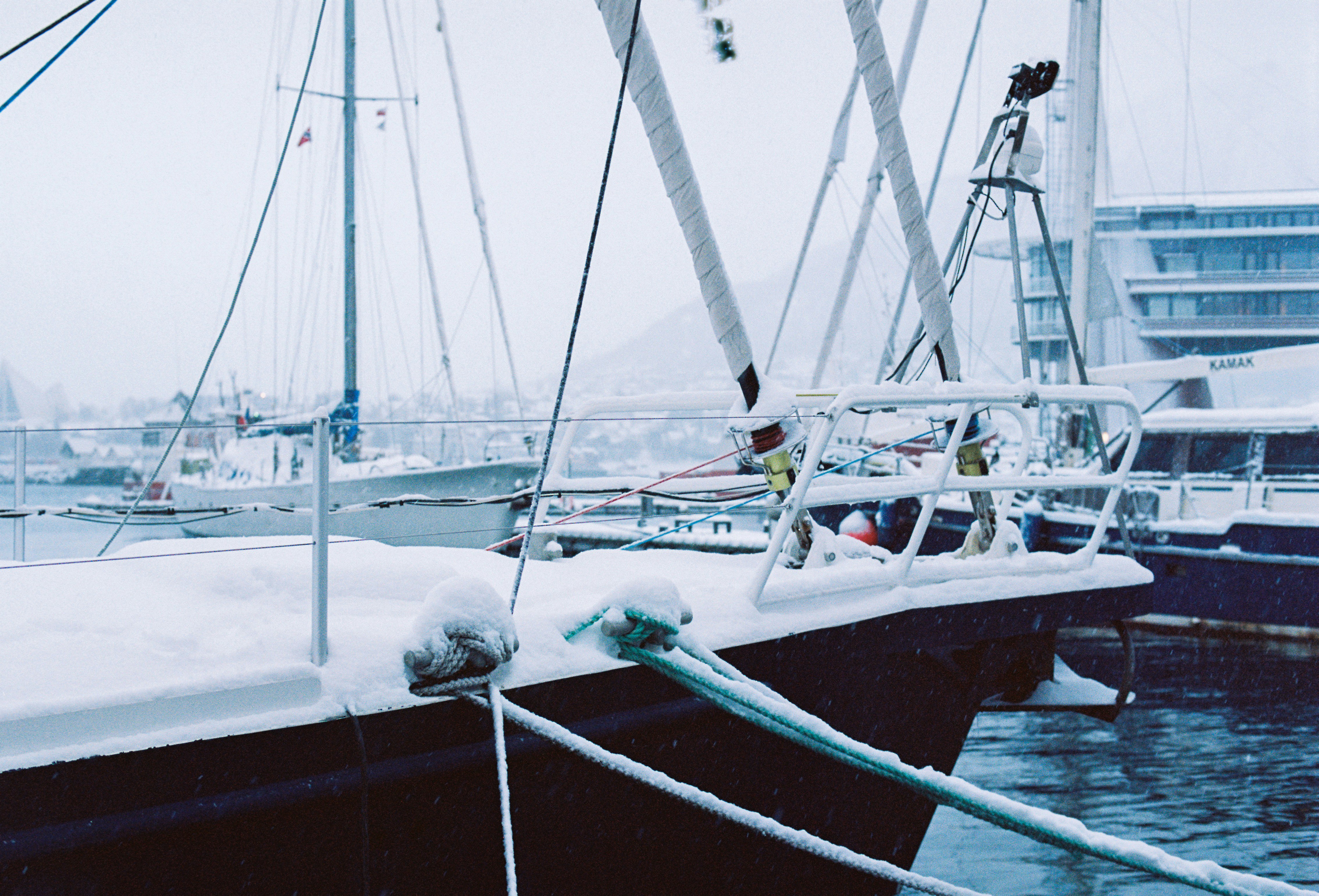 Boats are covered in snow at the harbor. photo – Free Winter Image on ...