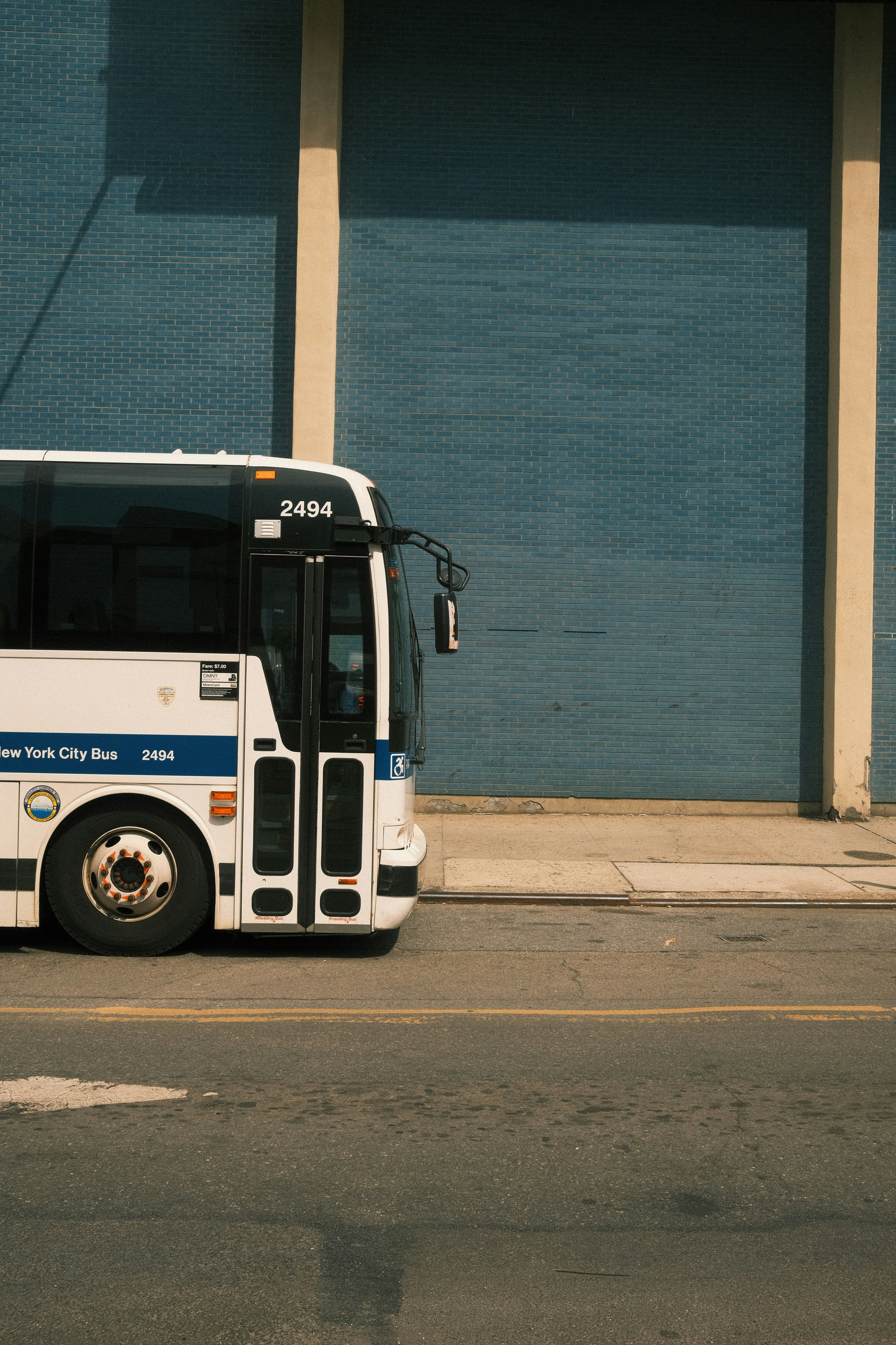 A bus is parked near a textured wall. photo – Free Vehicle Image on ...