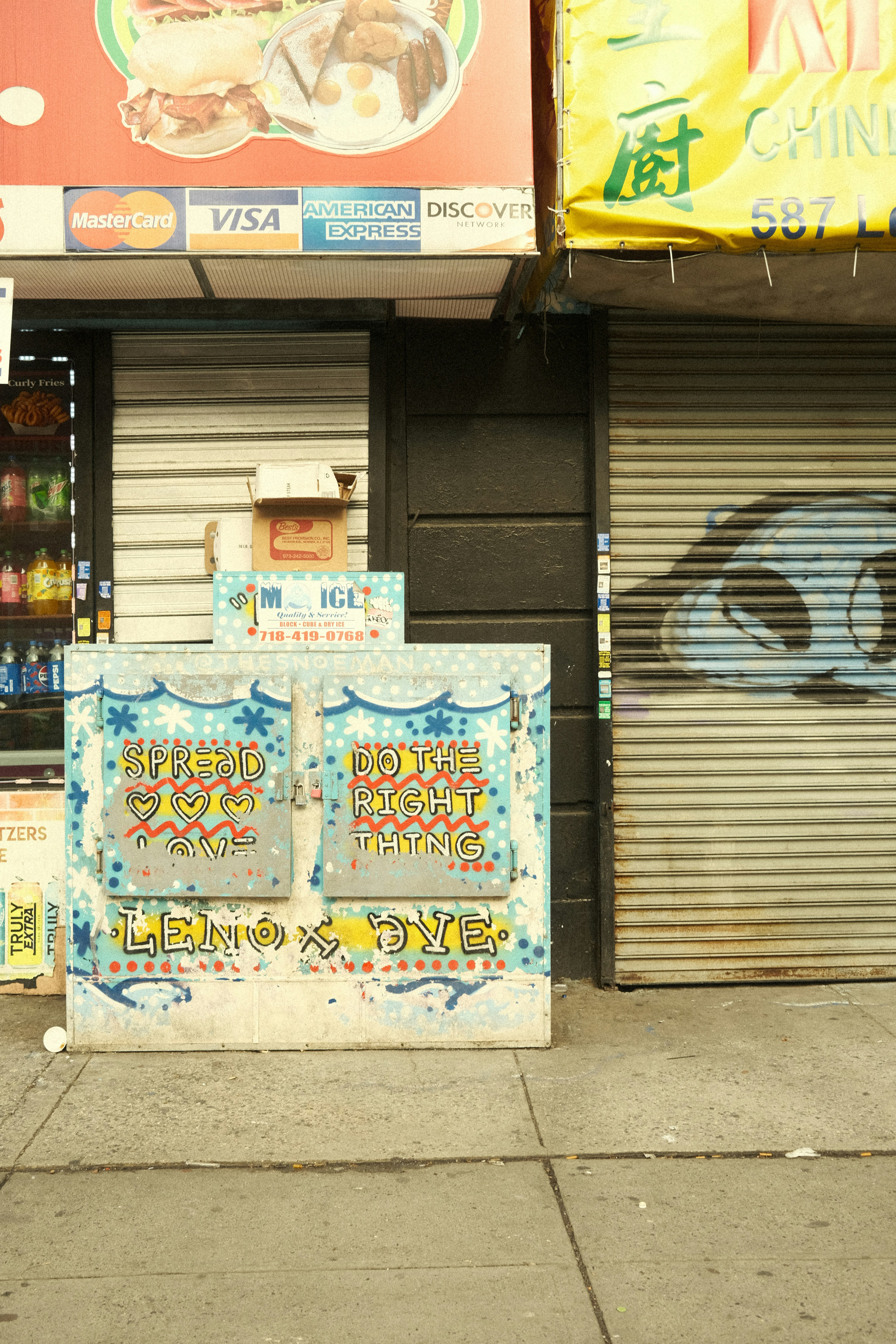 A storefront displays colorful signs and closed shutters. photo – Free ...