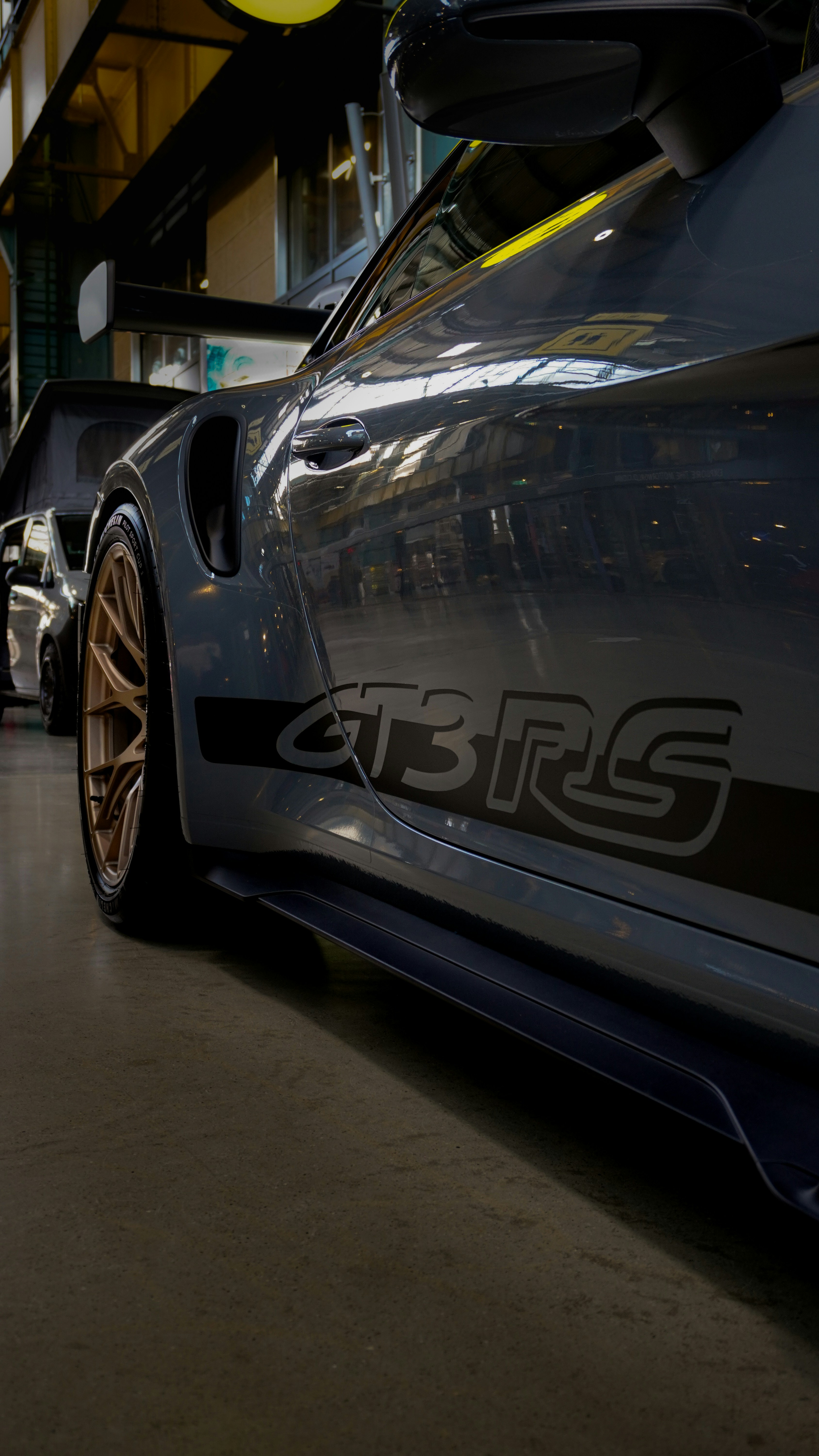 Low-Angle Glance at a Center-Stage GT3 RS on Showroom Floor
