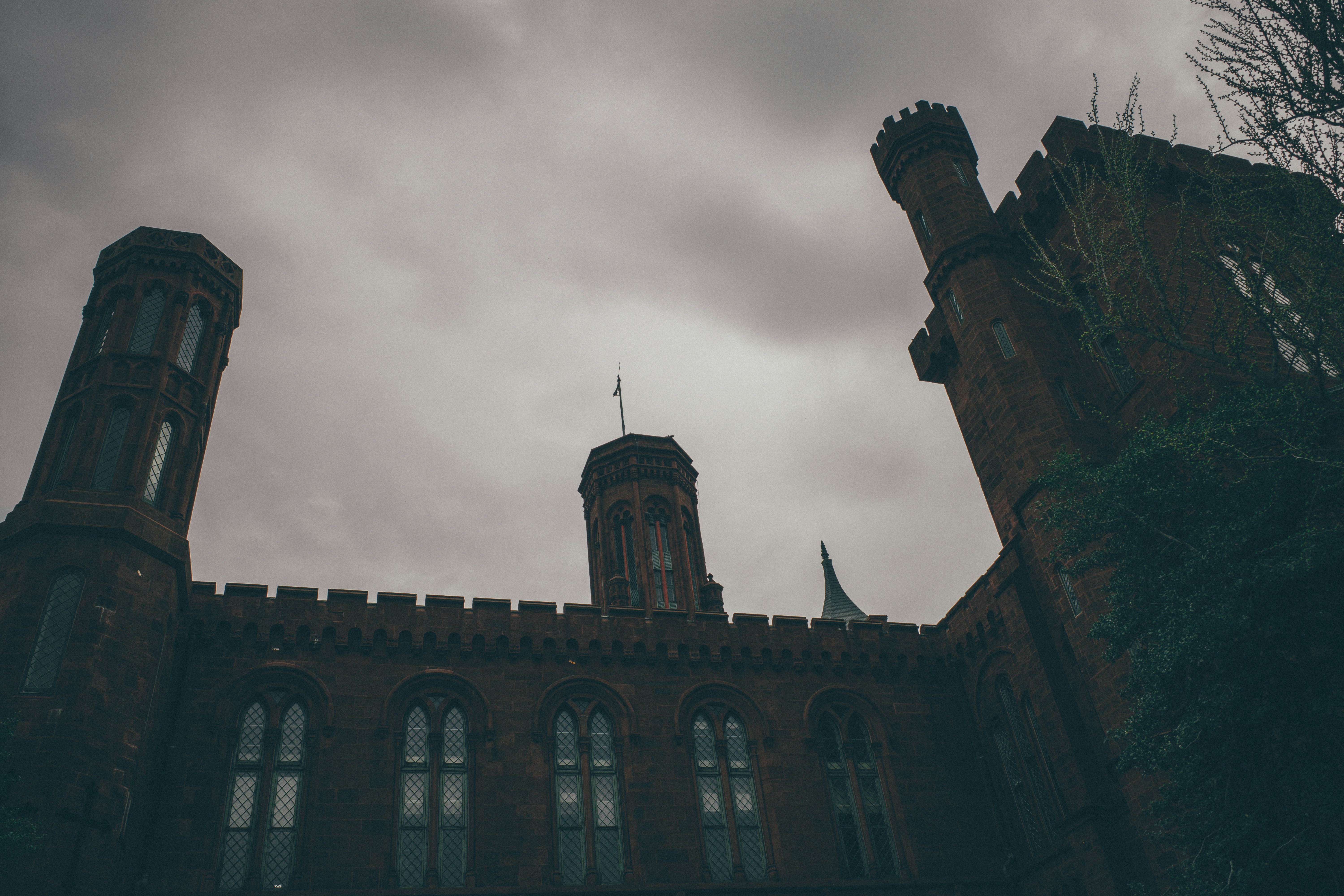 An ominous castle looms under a cloudy sky. photo – Free Building Image ...