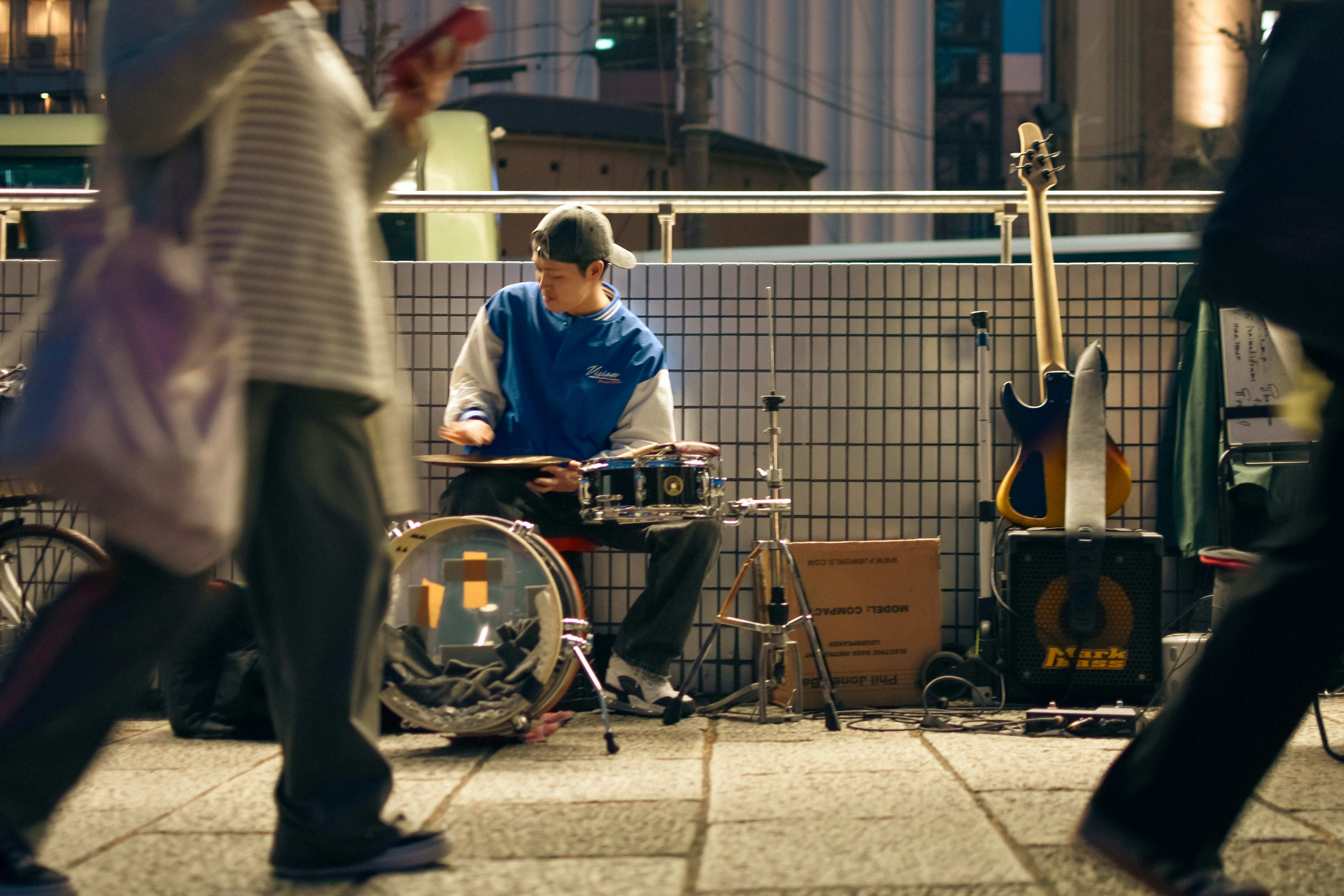 Busking in the Blurred Crowd: A Drummer Hidden Among Street Motion