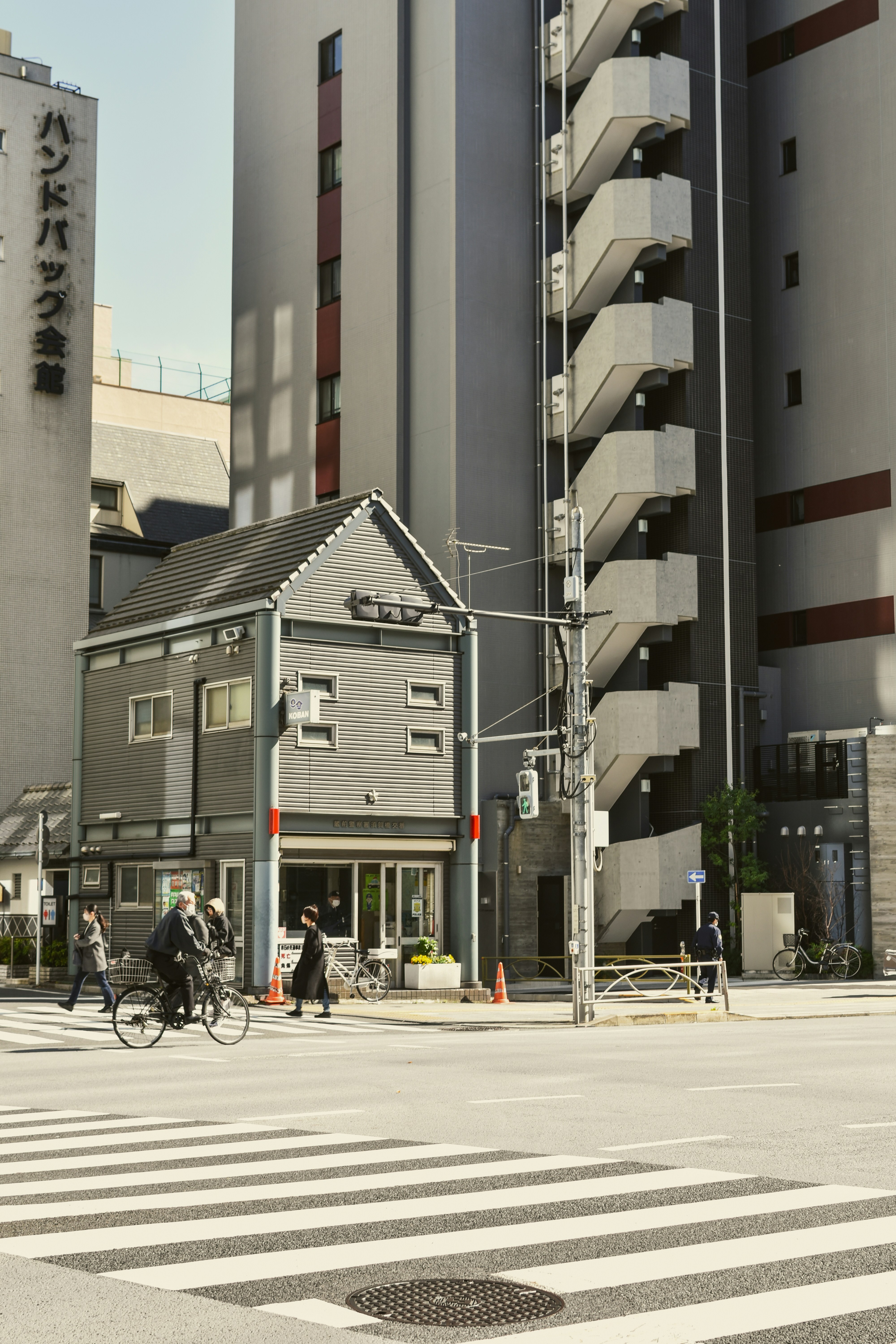 A small house stands among taller buildings. photo – Free Street ...