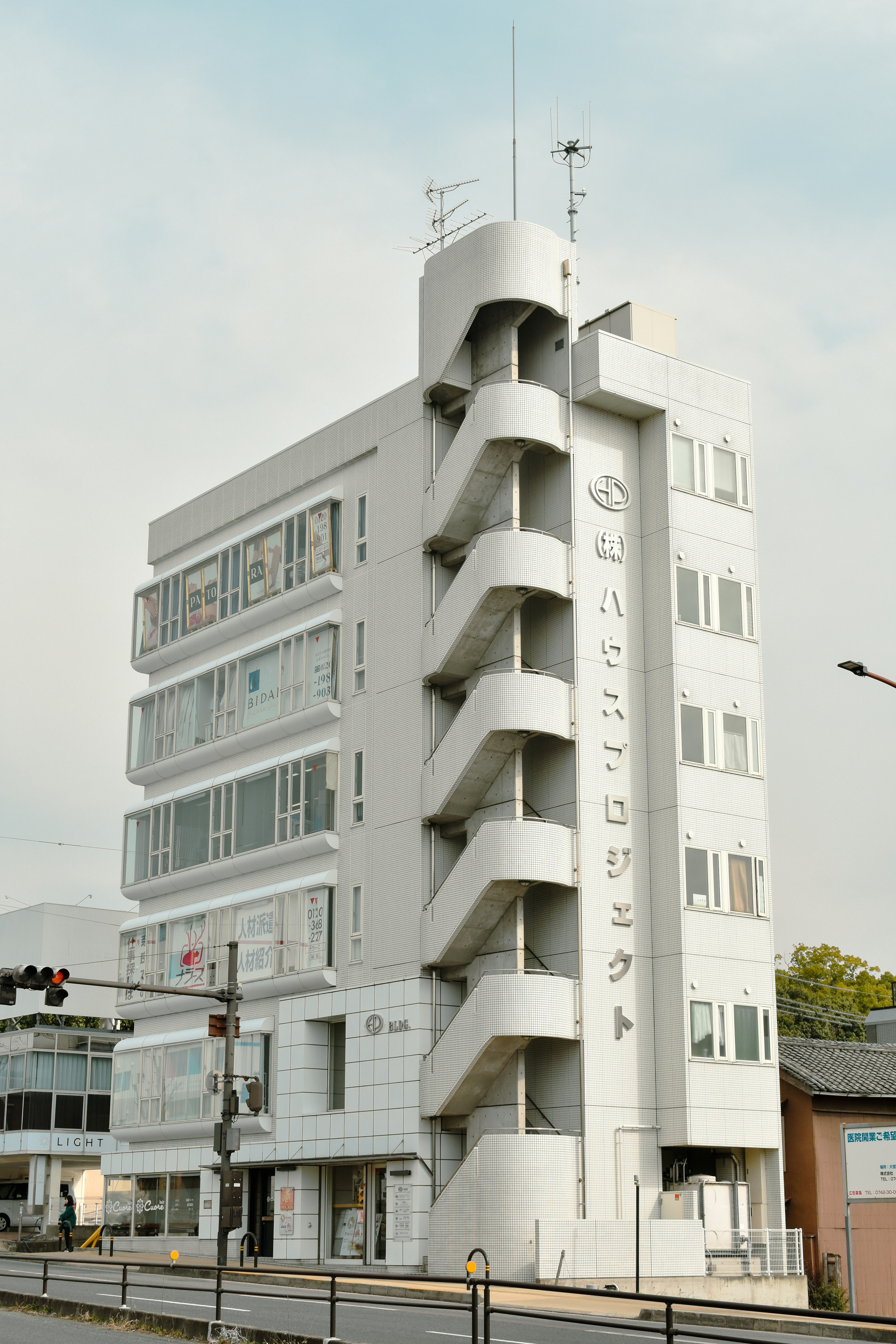 Spiral Staircase Framing on a Minimalist White Facade