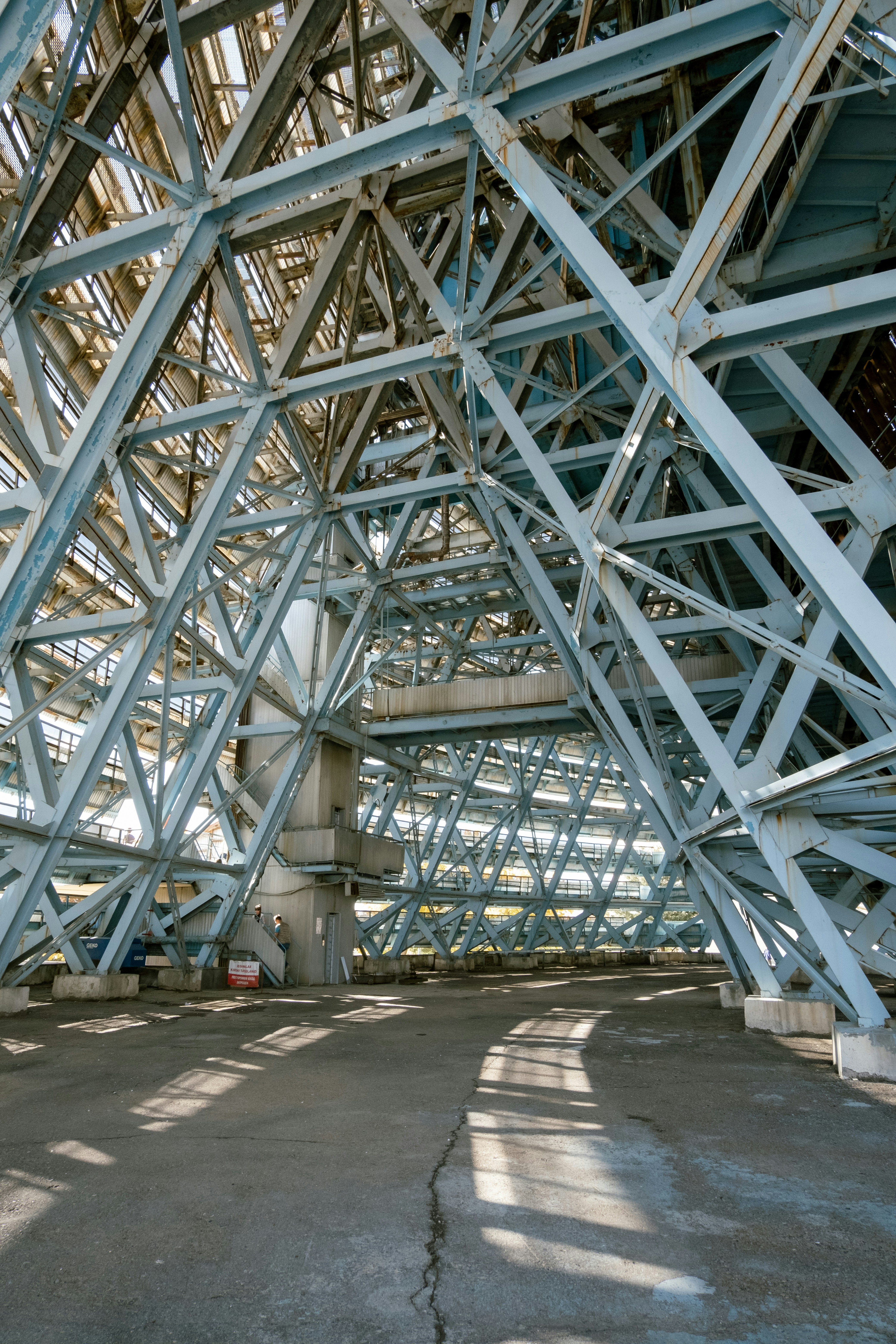 Here's a caption: steel beams form an intricate, geometric structure ...
