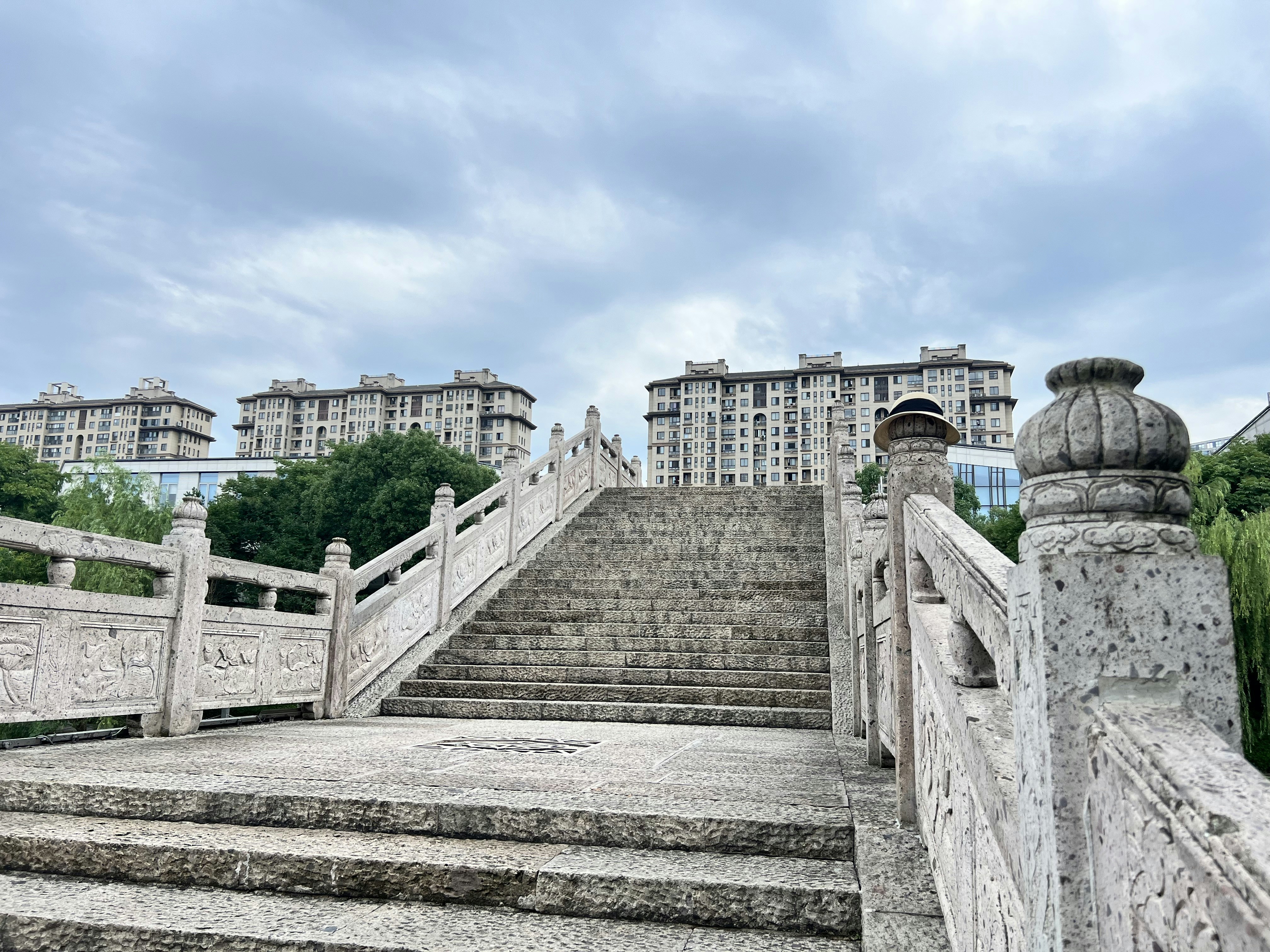 A stone bridge leads to apartment buildings. photo – Free Building ...