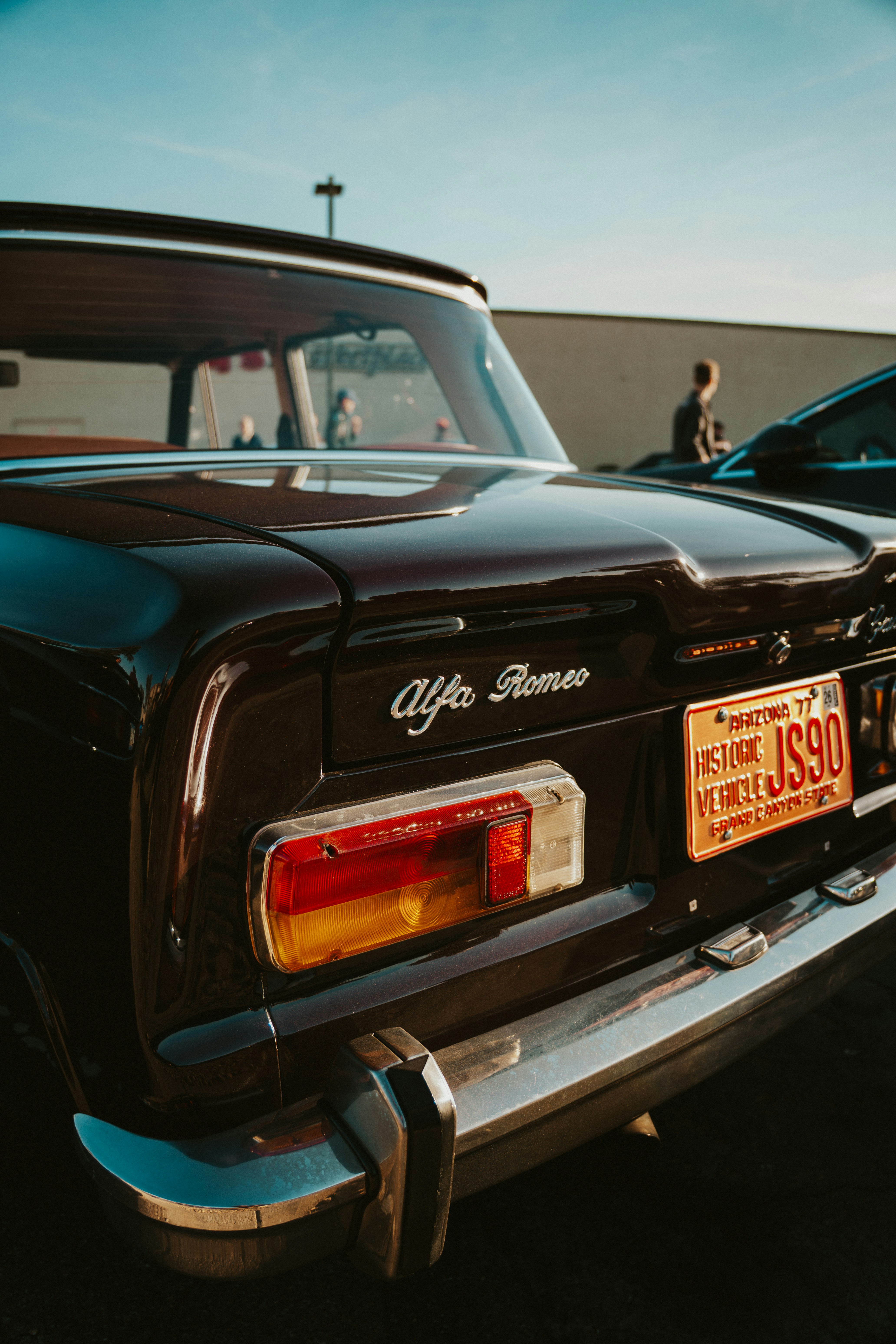 Chrome Contours under Golden Hour: A Retro Alfa Romeo at a Car Show