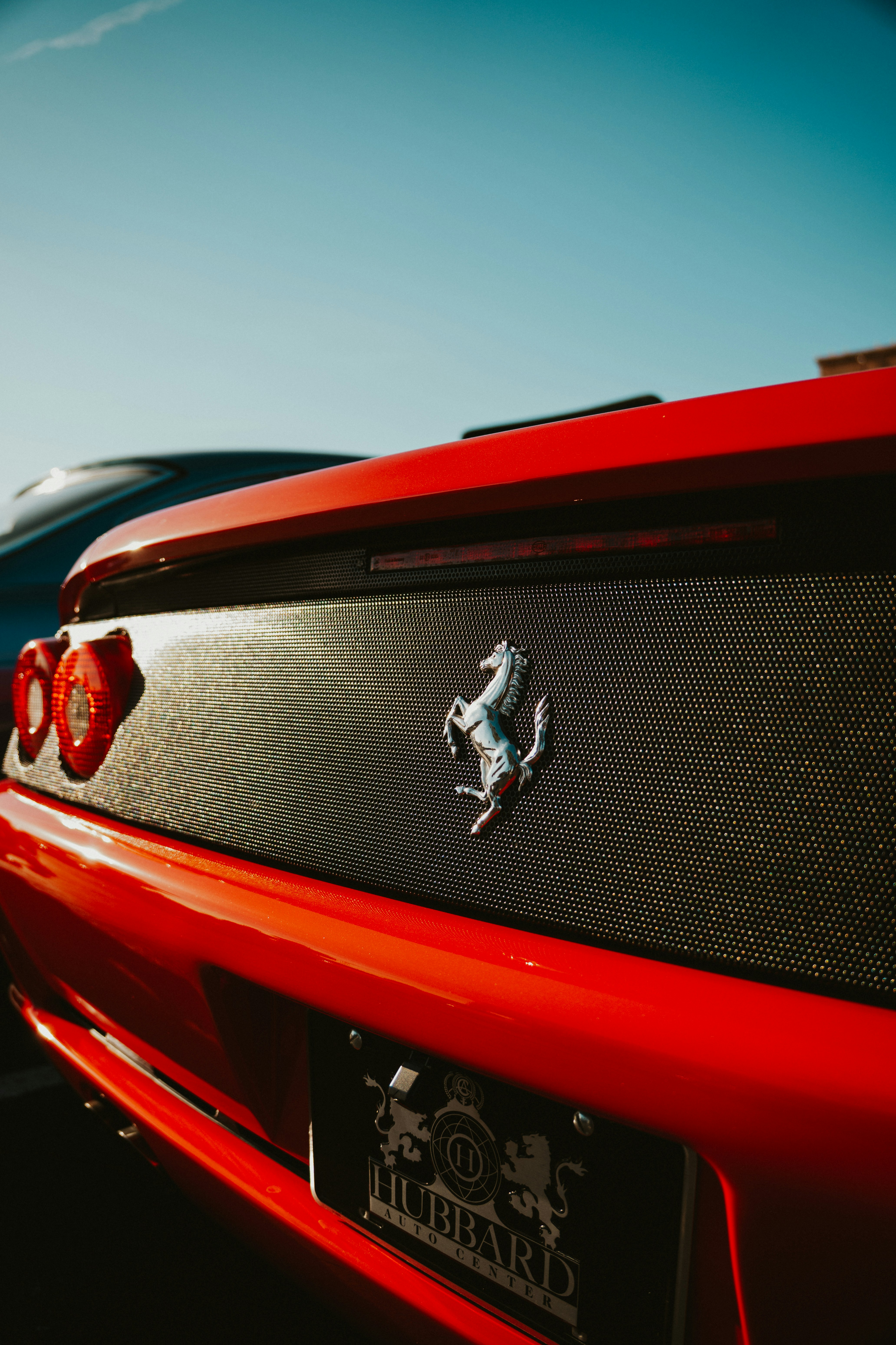 A red ferrari's tail featuring the iconic logo. photo – Free Car Image ...