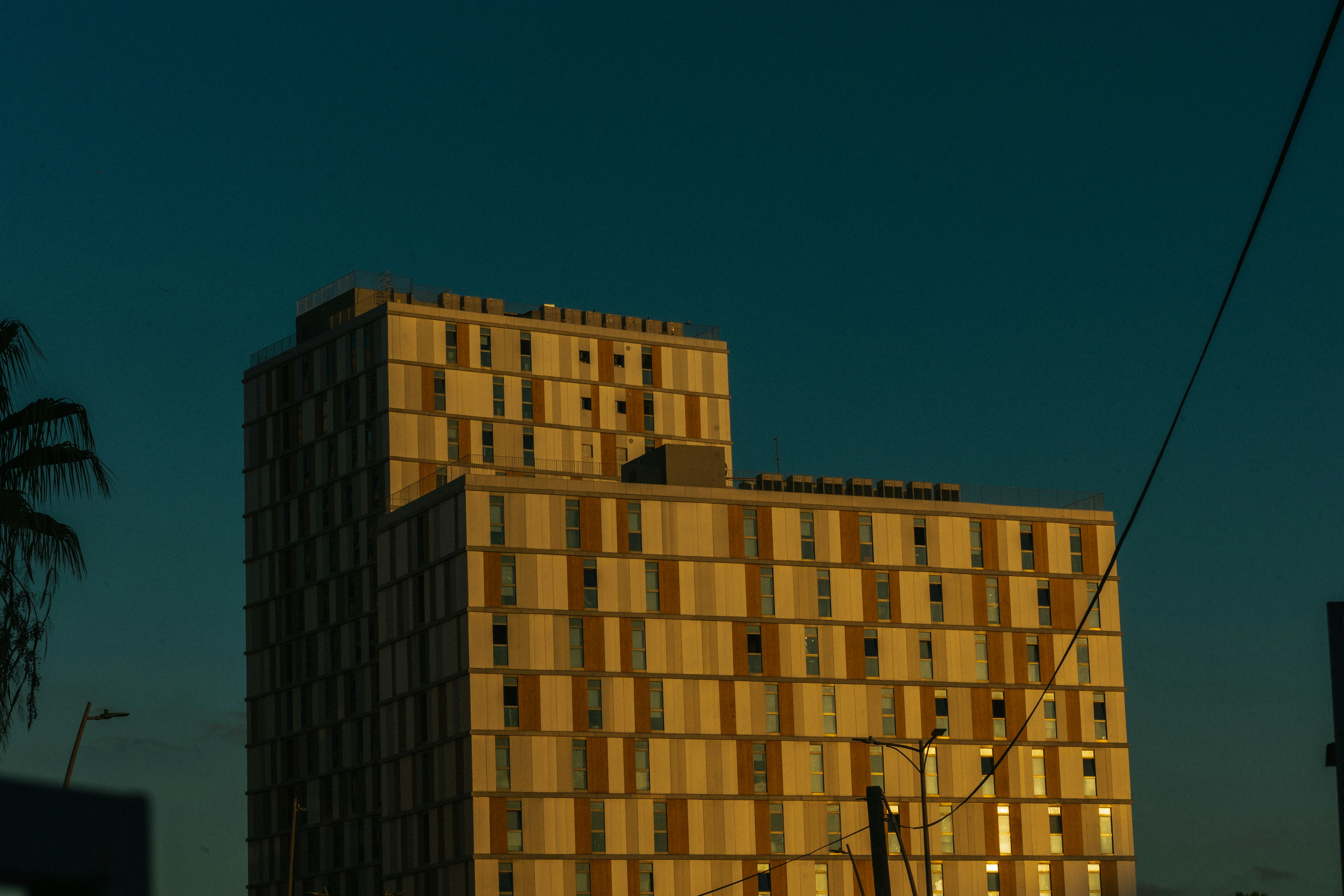 Dusky Grid: Sunlit Facade of a Modern Apartment Block