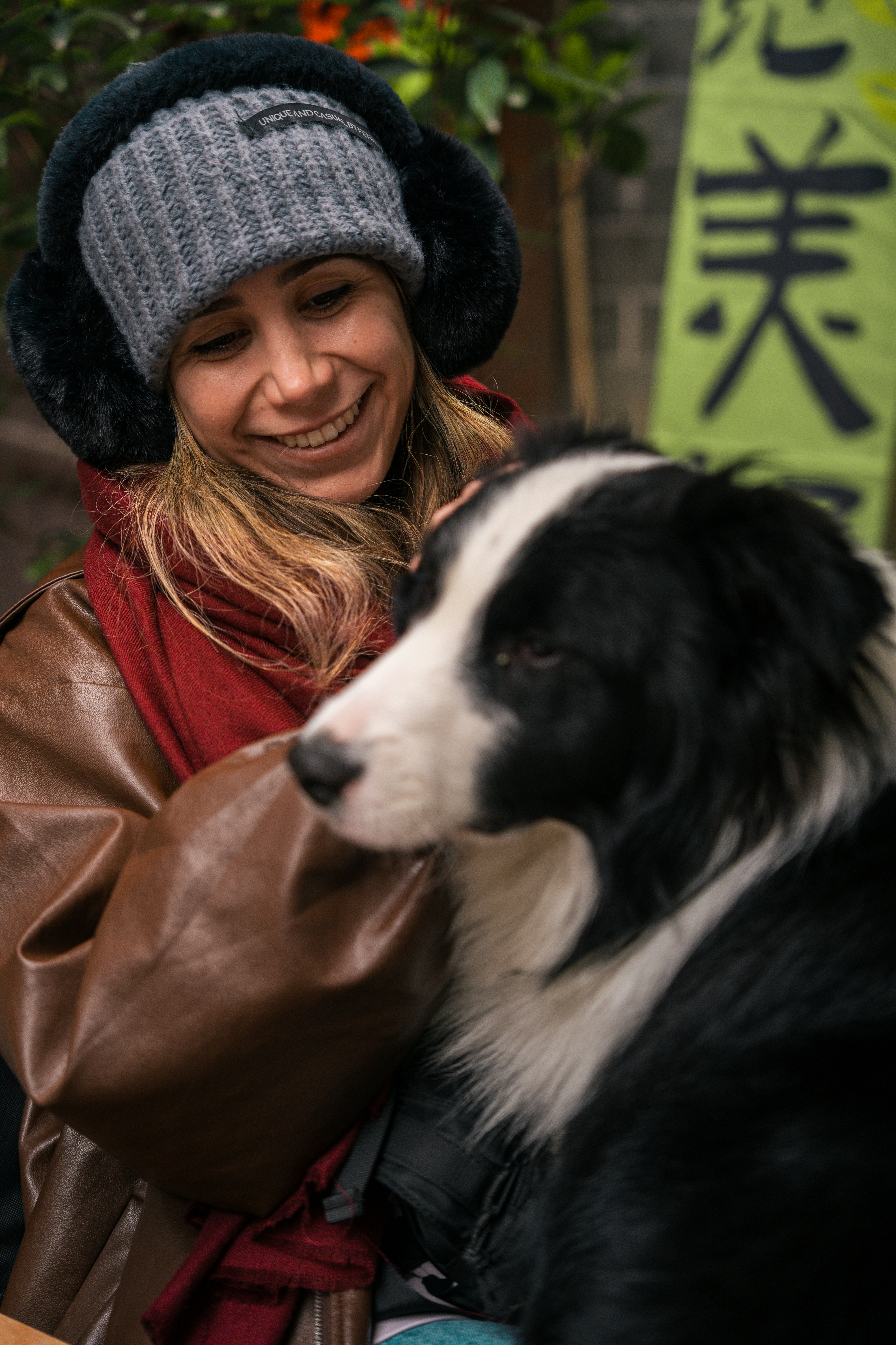 Cozy Glance: A Woman and Her Border Collie in Soft Street Light