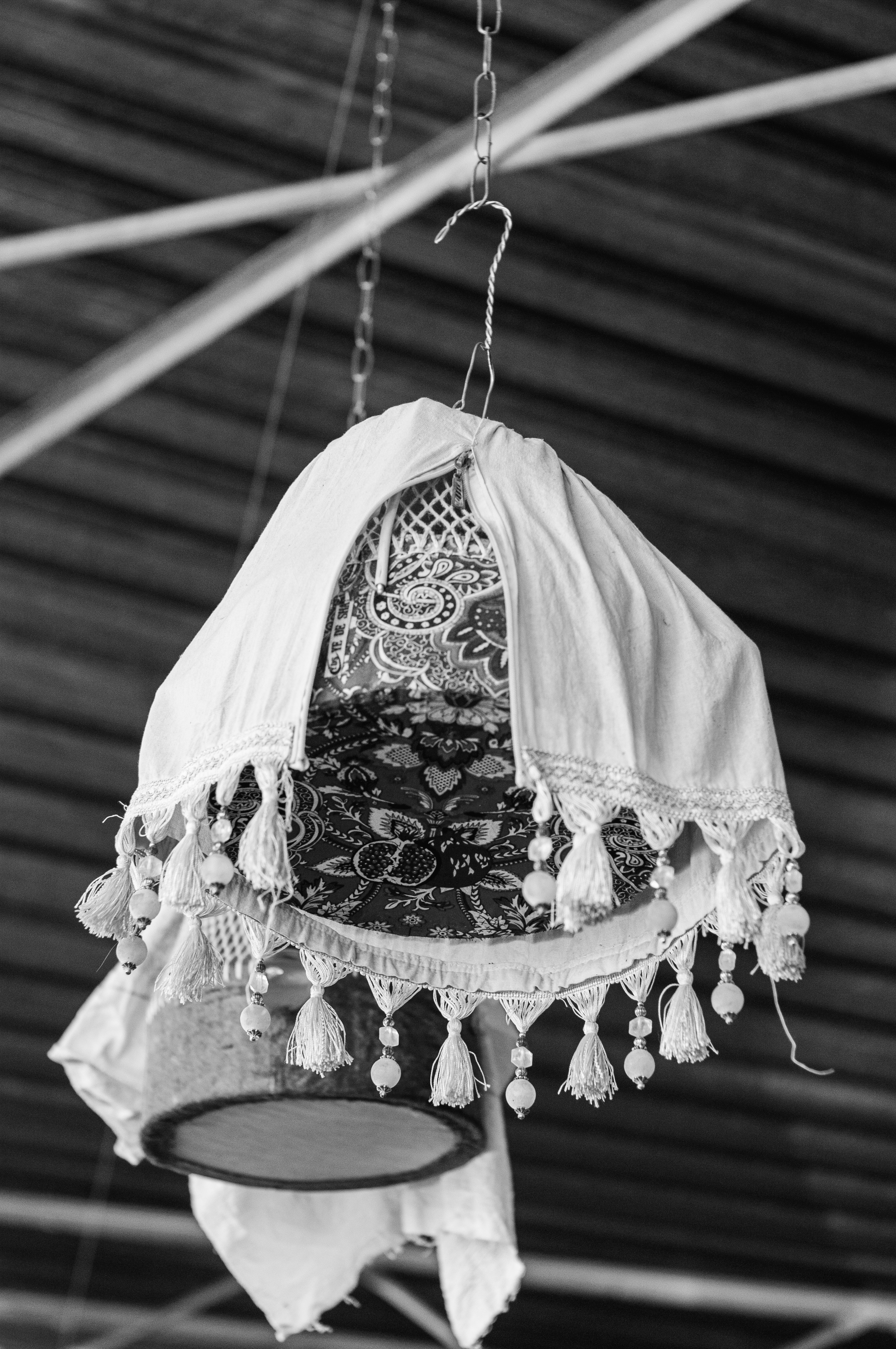 Lace Lantern under Industrial Beams: A Quiet Monochrome Moment