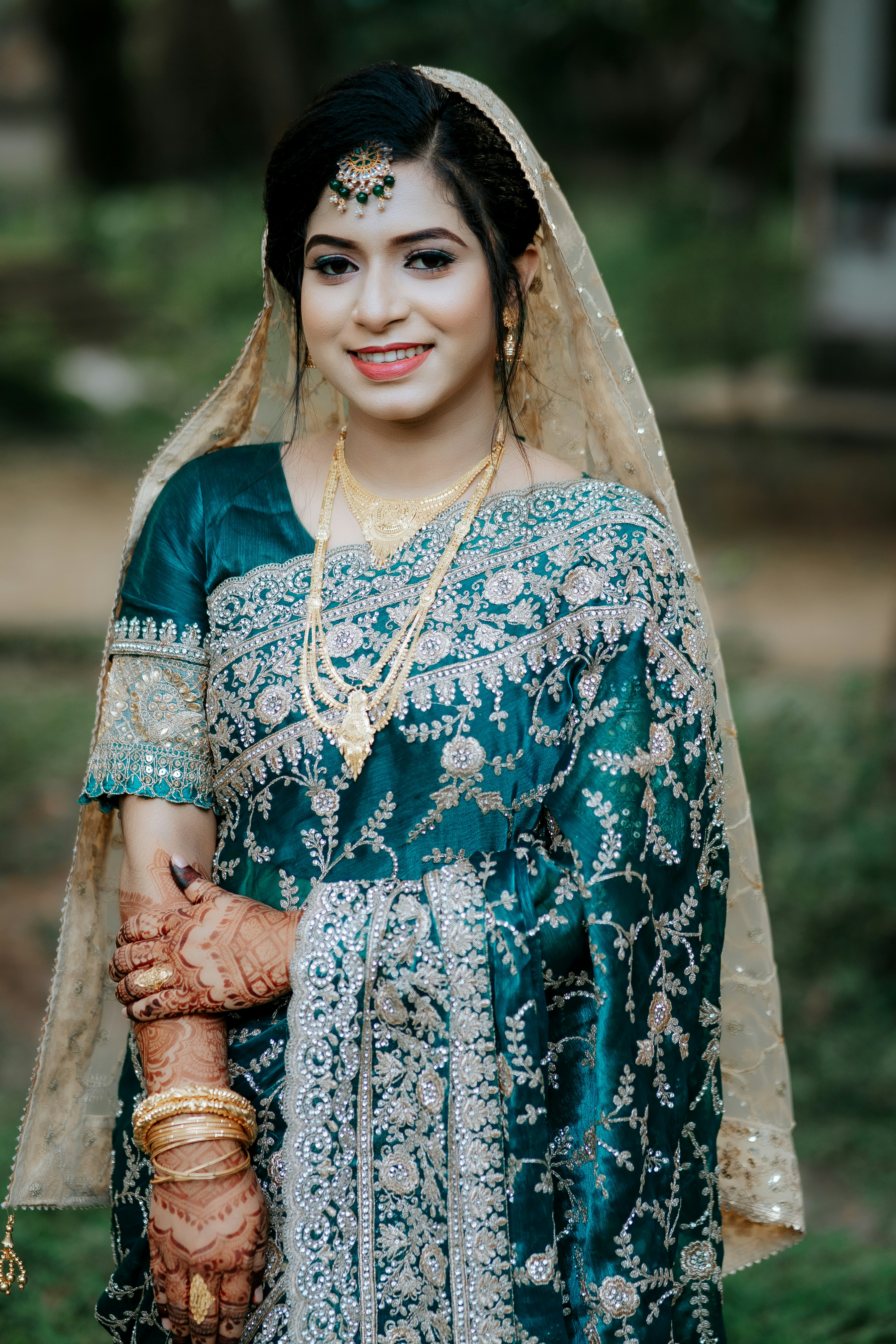 A beautiful bride is posed in a teal saree. photo – Free Wedding Image ...