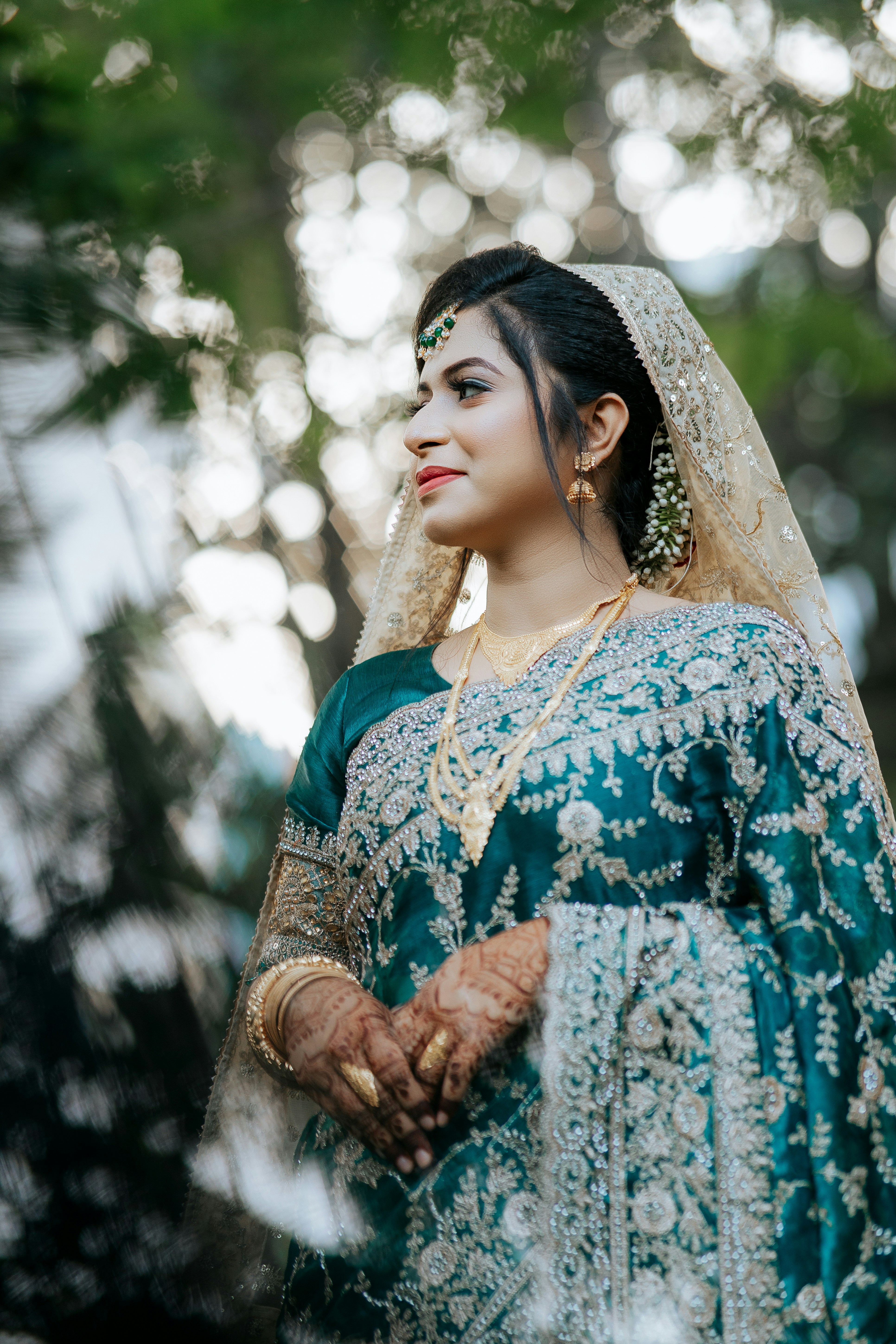 A beautiful bride poses in a teal saree. photo – Free Wedding Image on ...