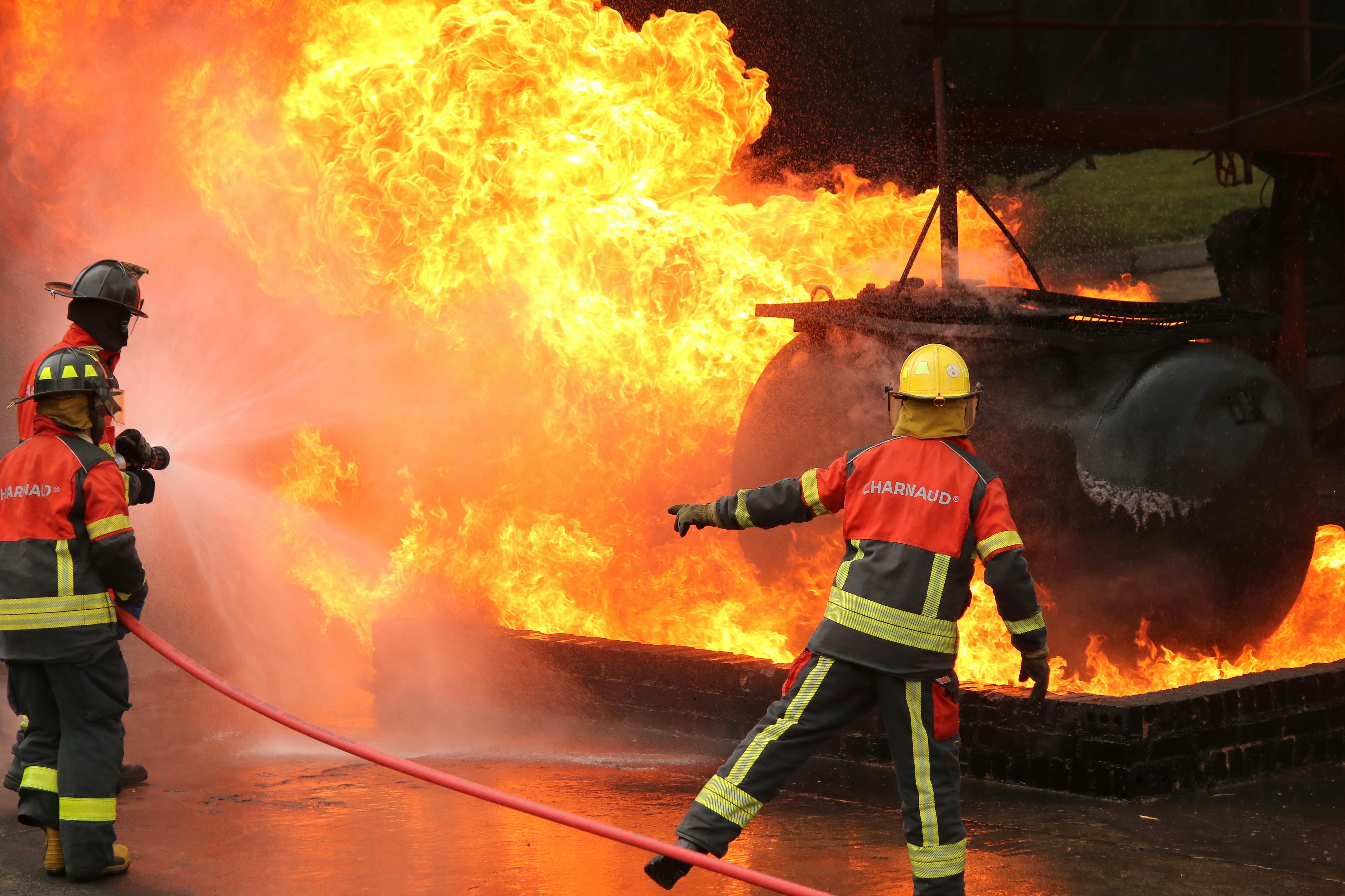 Firefighters battle a raging fire with water hoses. photo – Free Human ...