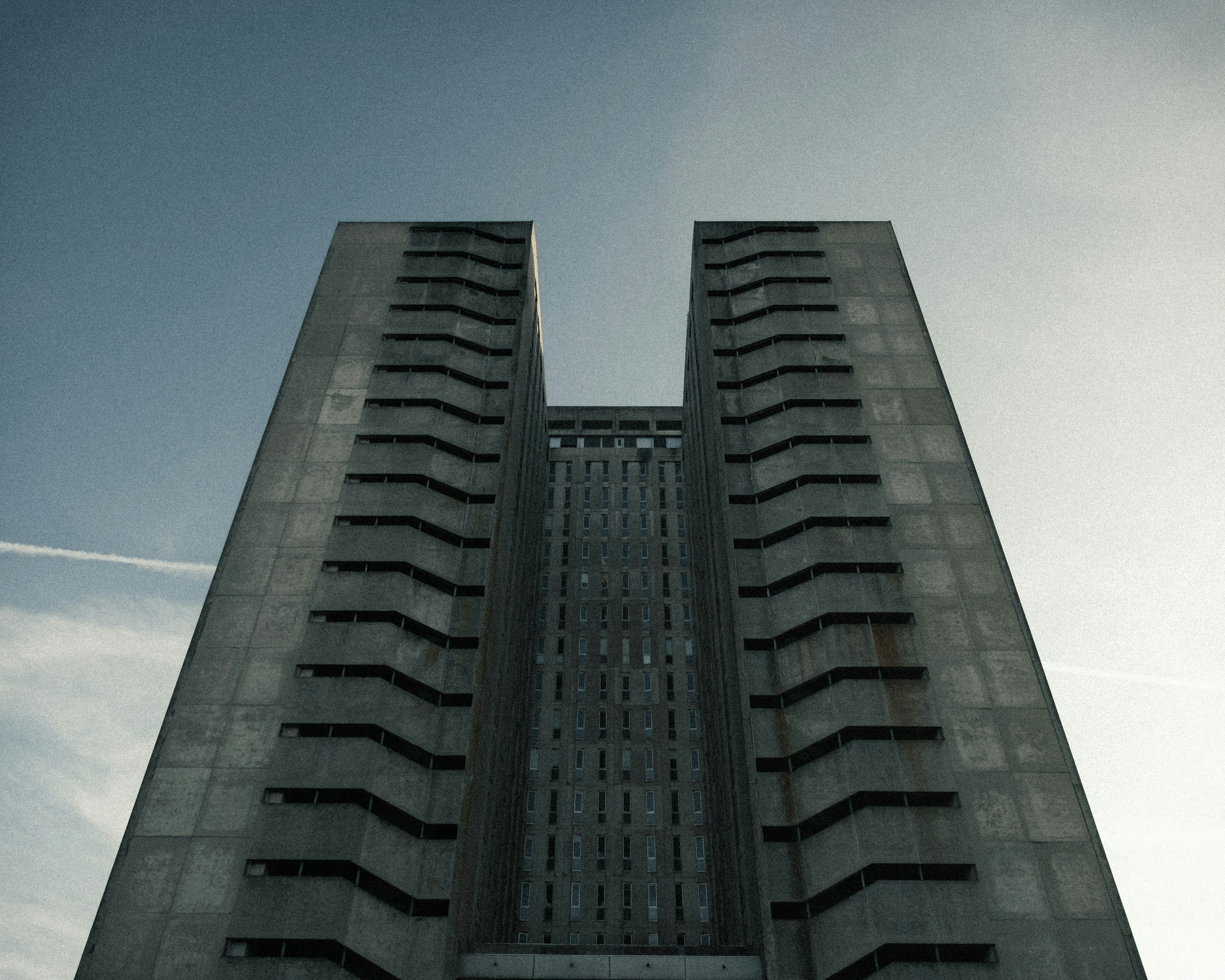 A towering, symmetrical concrete building reaching skyward. photo ...