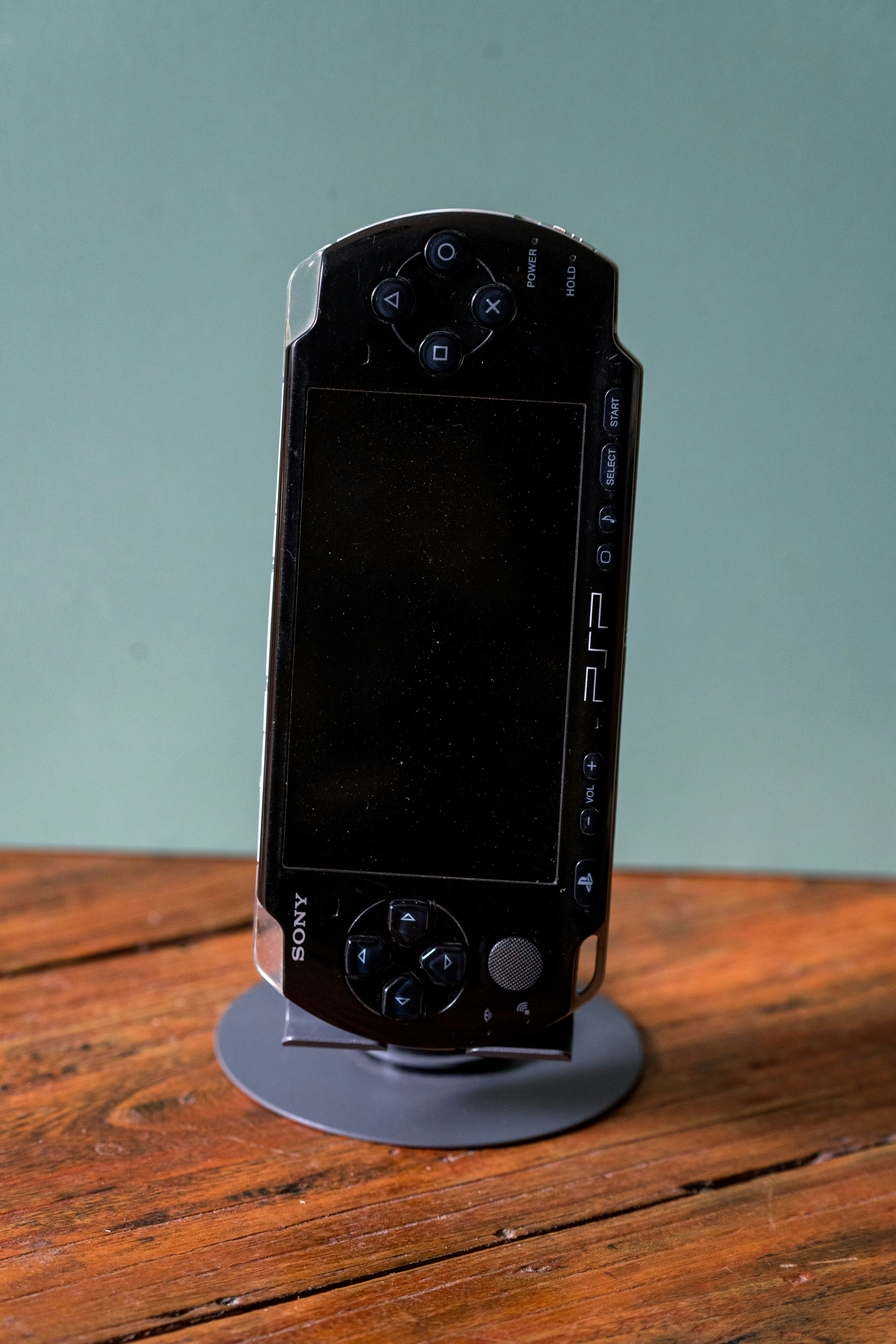 A black psp handheld console is on display. photo – Free Phone Image on ...