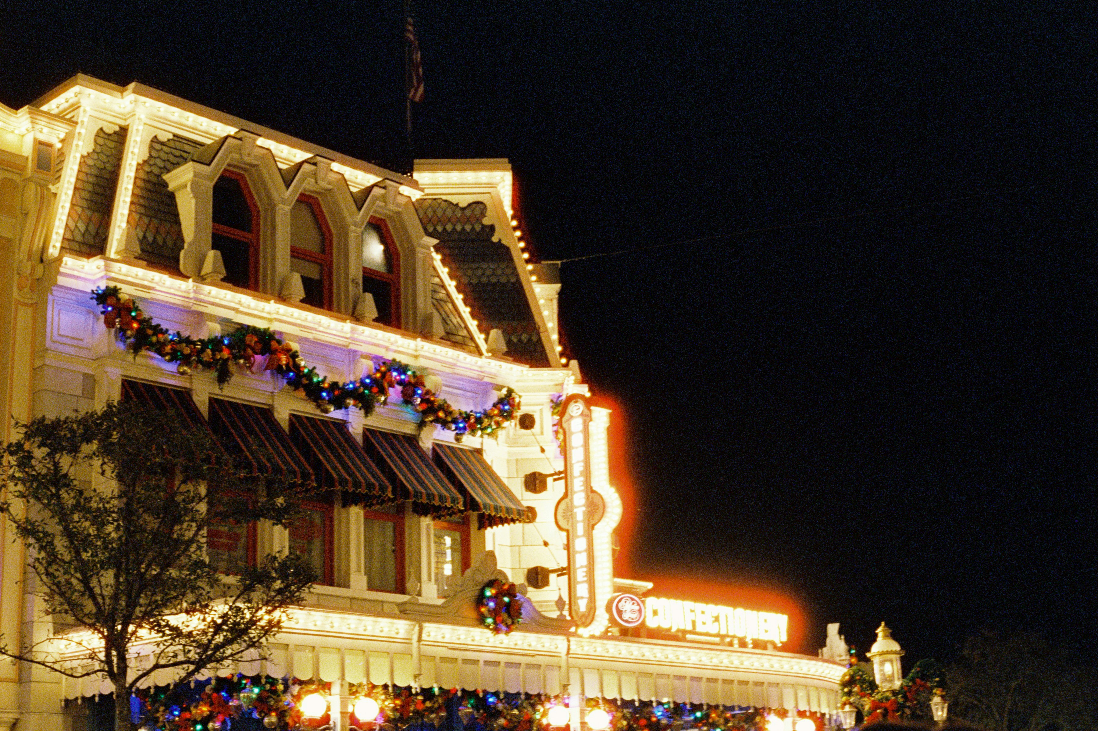 Disney World Photography - Christmas at Magic Kingdom Canon AE-1 Program Cinestill 800T | The beautiful building is lit up at night.