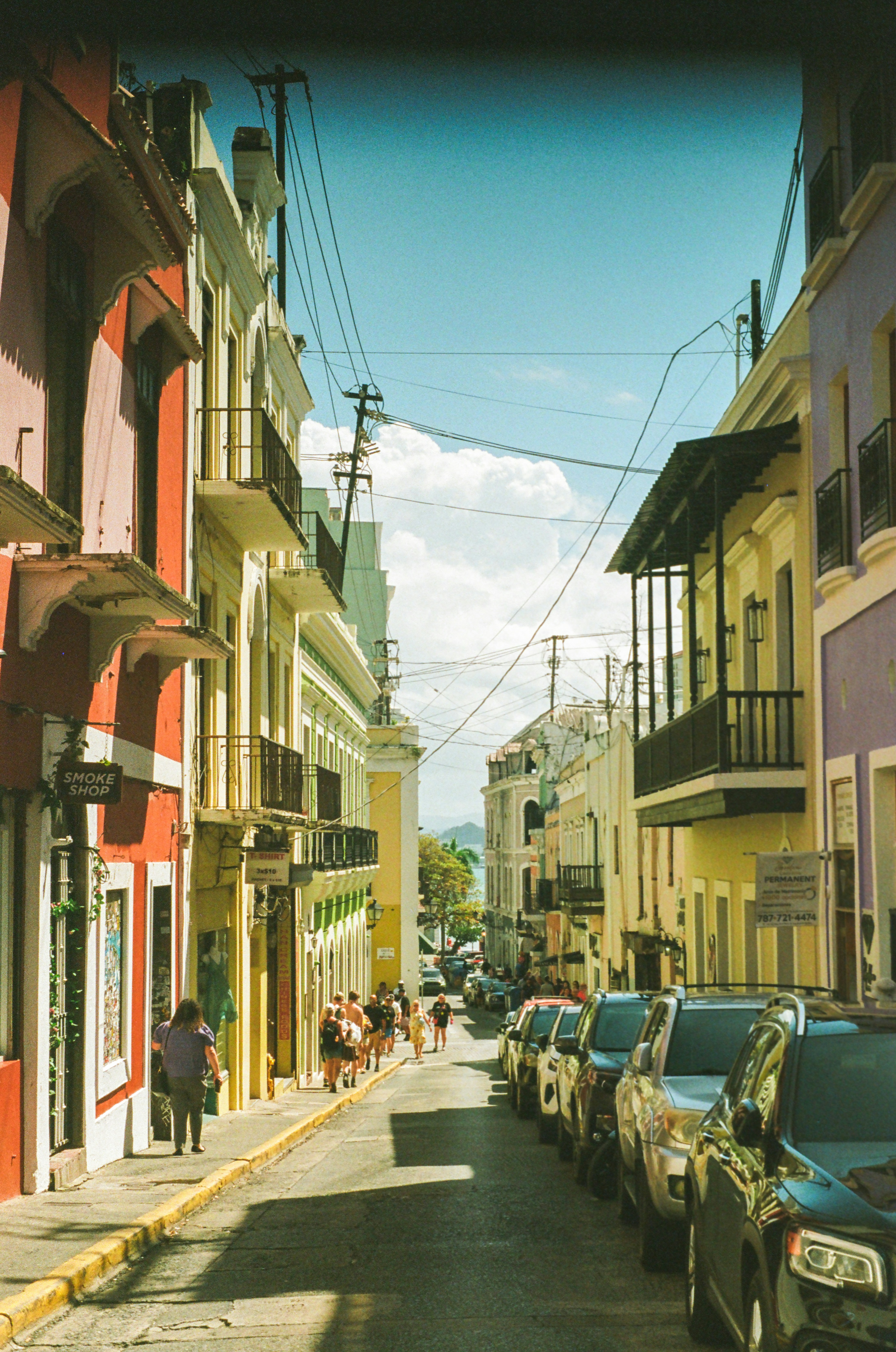 Colorful buildings line a street in a sunny town. photo – Free Car ...