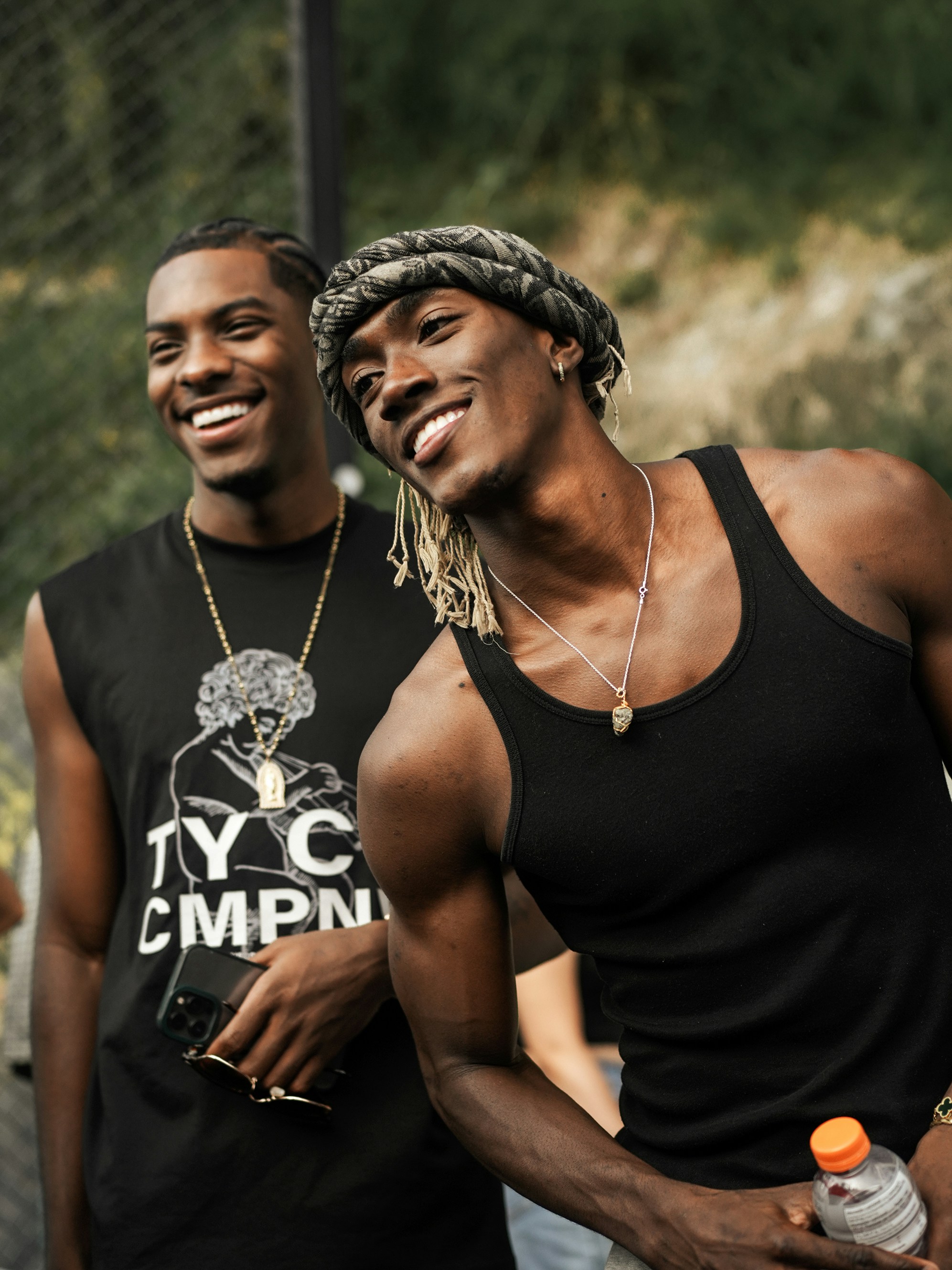 Two smiling young men are enjoying themselves outdoors. photo – Free ...