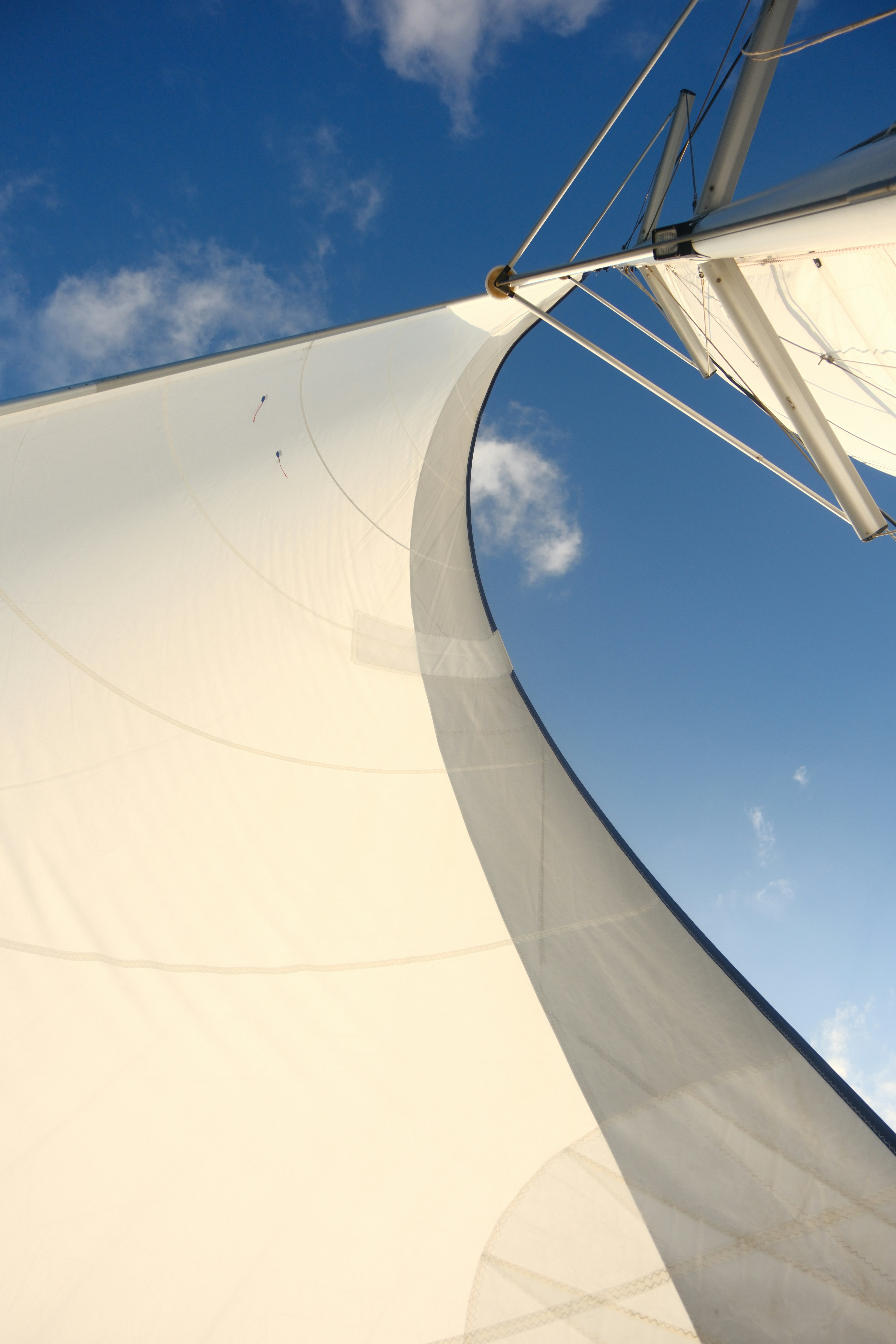 Sailboat sails billowing against a bright blue sky. photo – Free Car ...