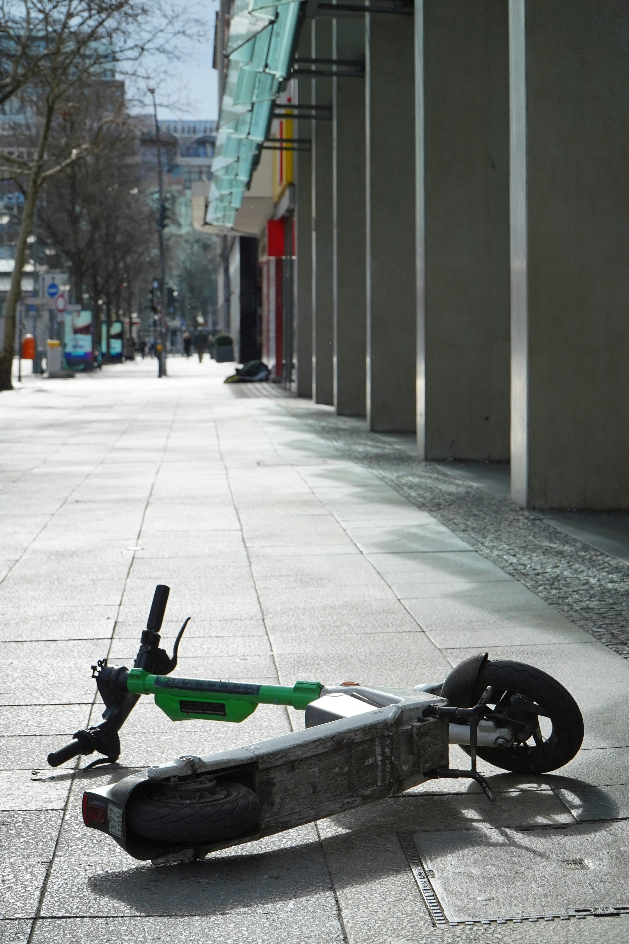 Urban Stillness: A Fallen Scooter's Tale