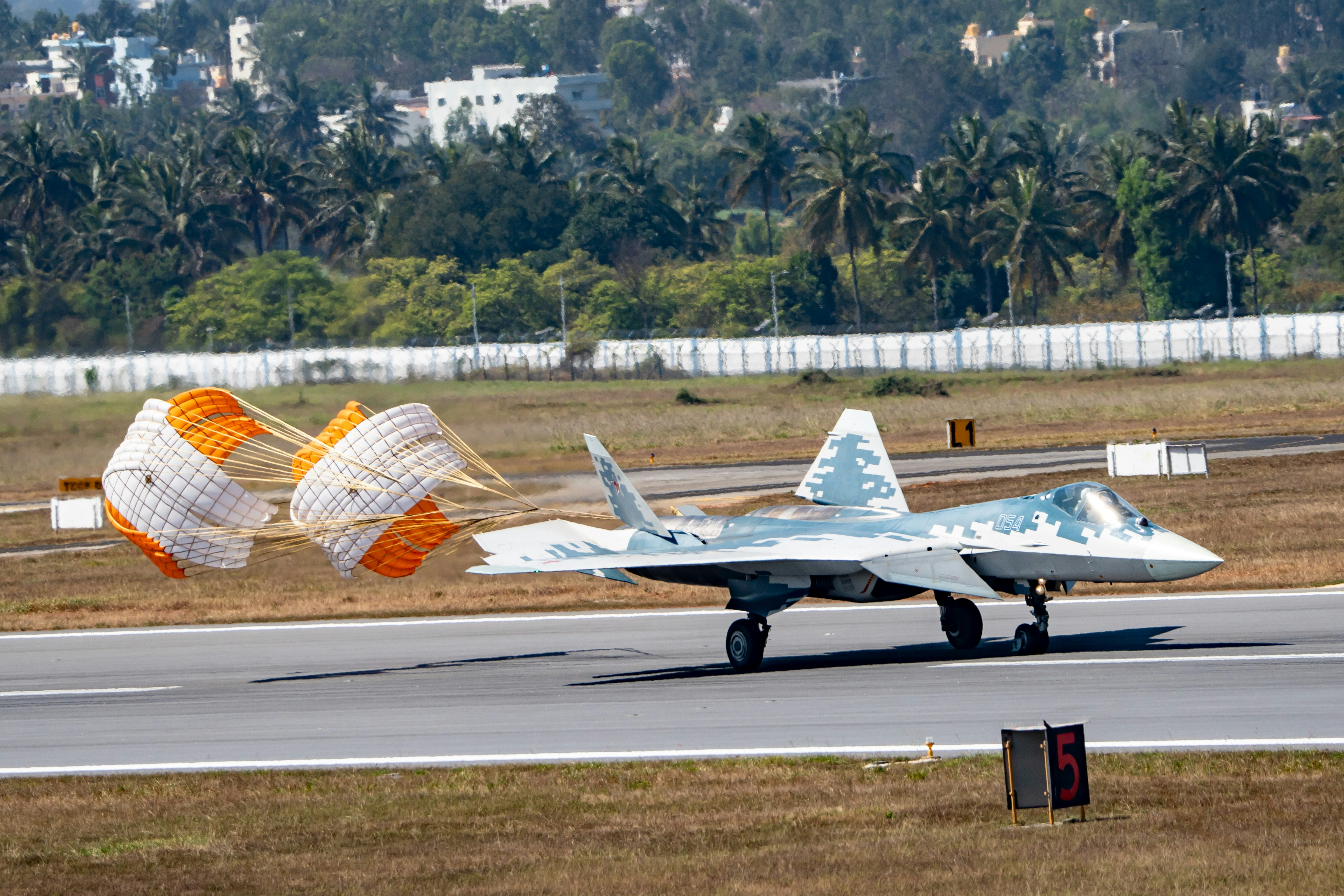 A fighter jet lands with deployed parachutes. photo – Free Beautiful ...