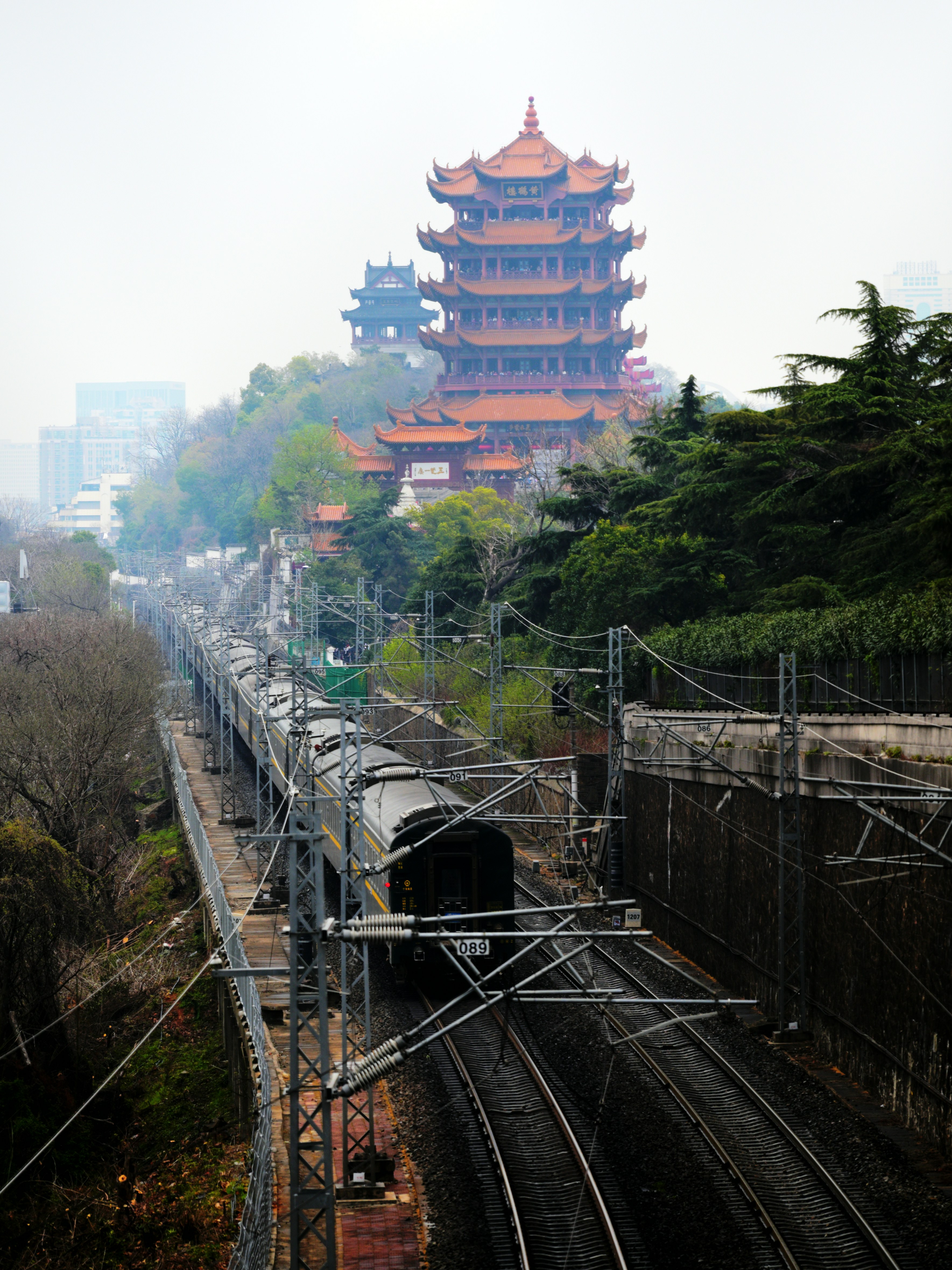 A train passes underneath a traditional chinese pagoda. photo – Free ...