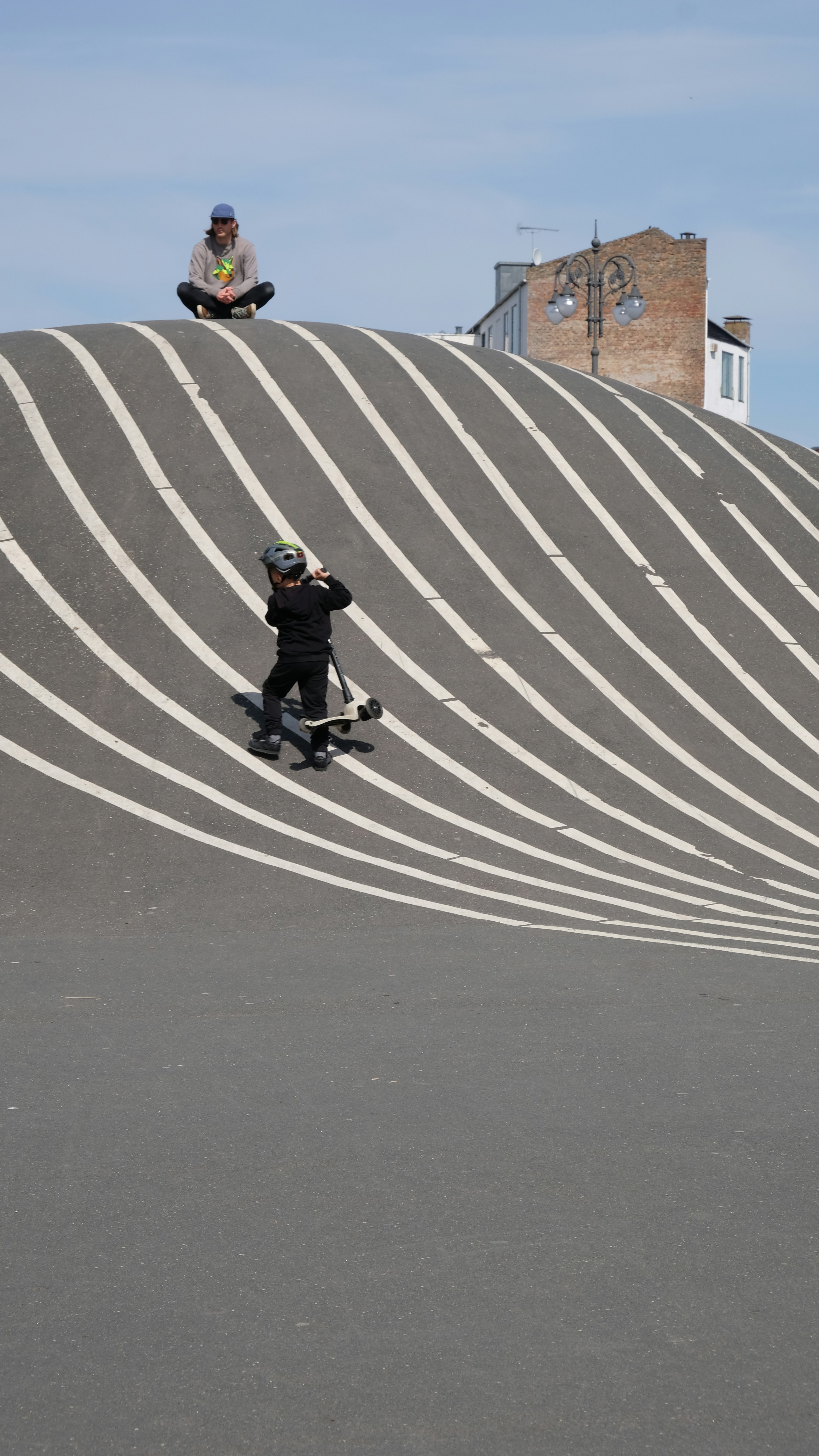 Striped Bowl Ride: A Skateboarder Cuts Through the Concrete Wave