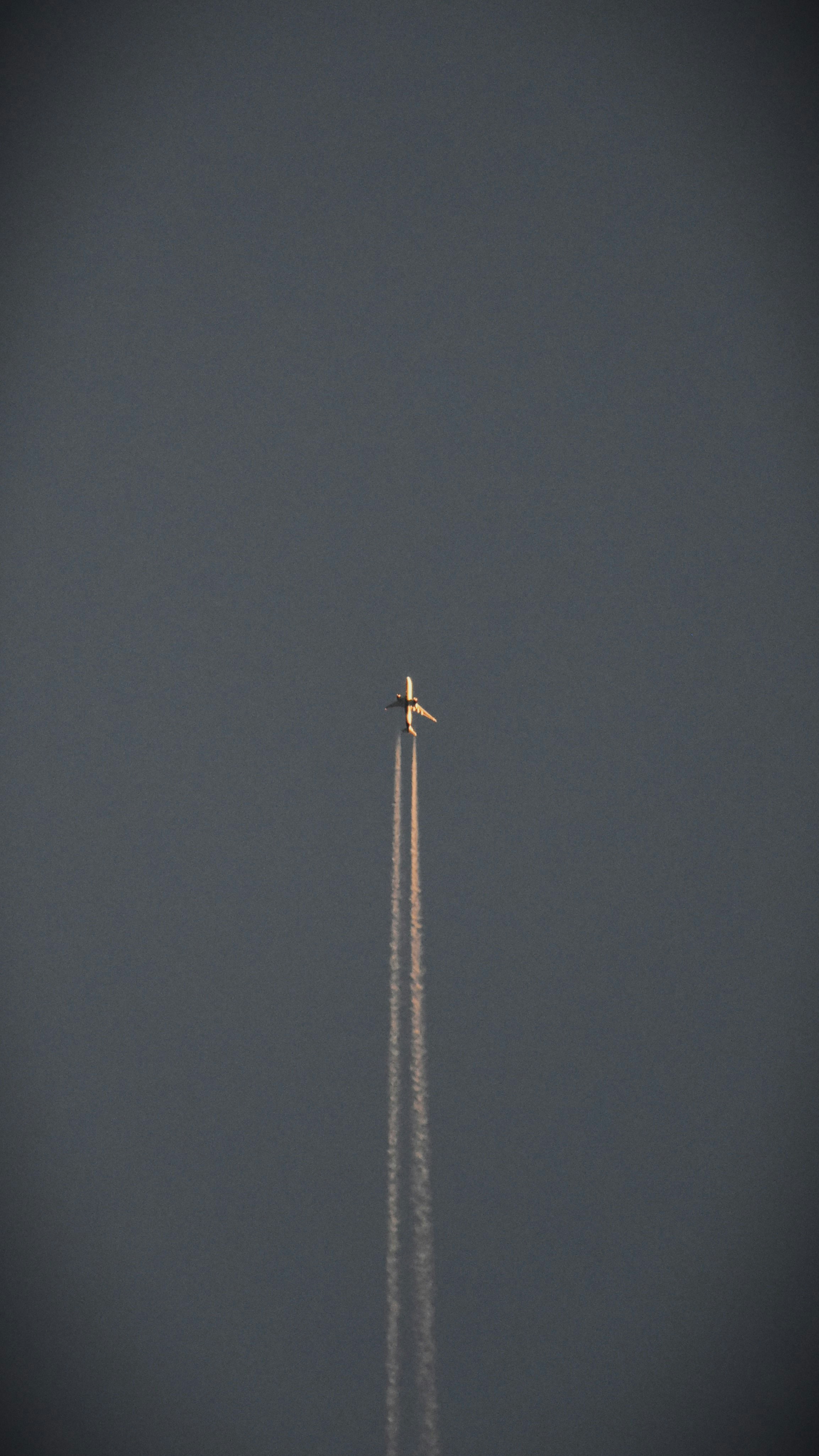 Jet Traces: A Lone Aircraft Climbing Through a Velvet Sky