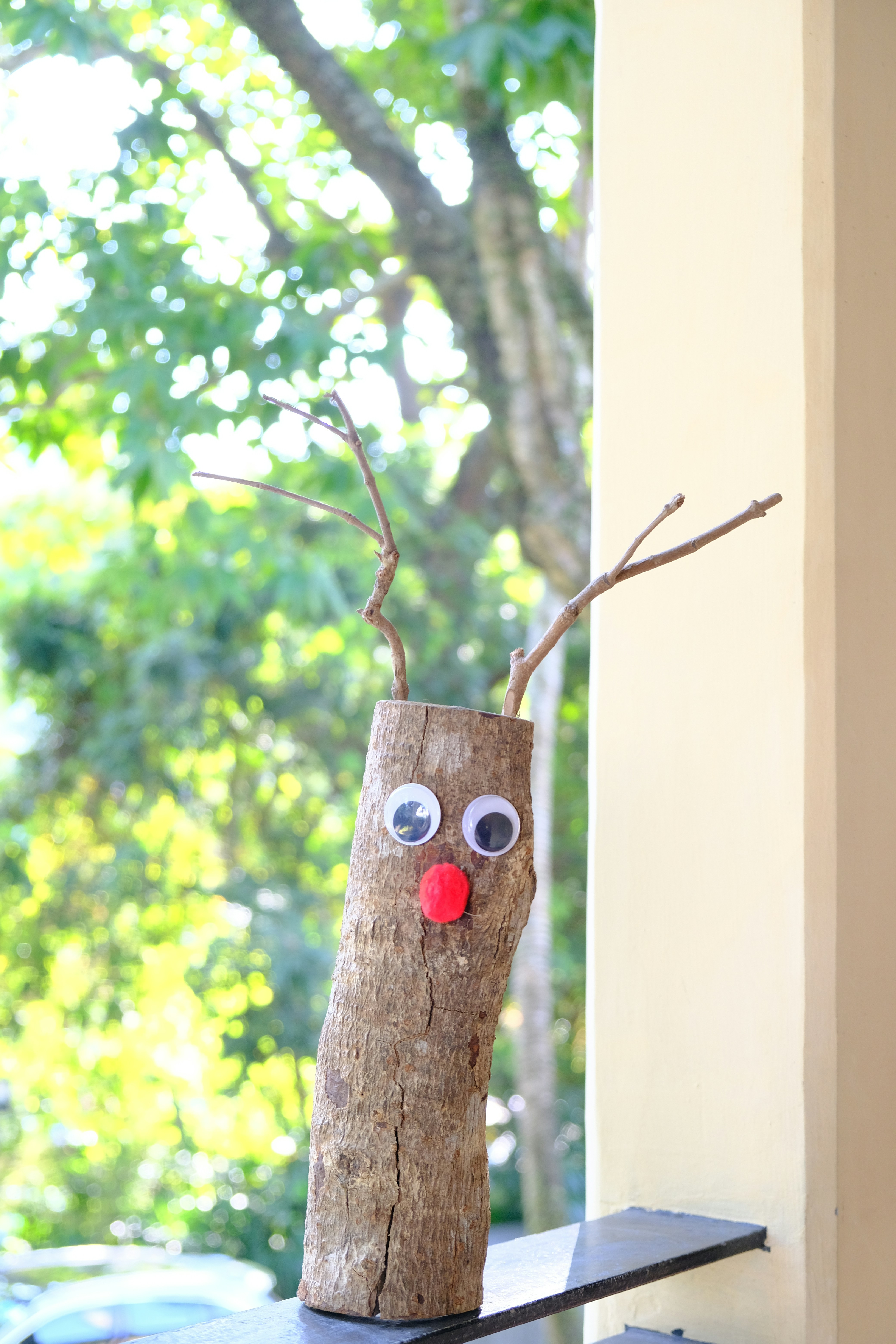 Smiling Log: A Jovial Stick Character Guards the Porch