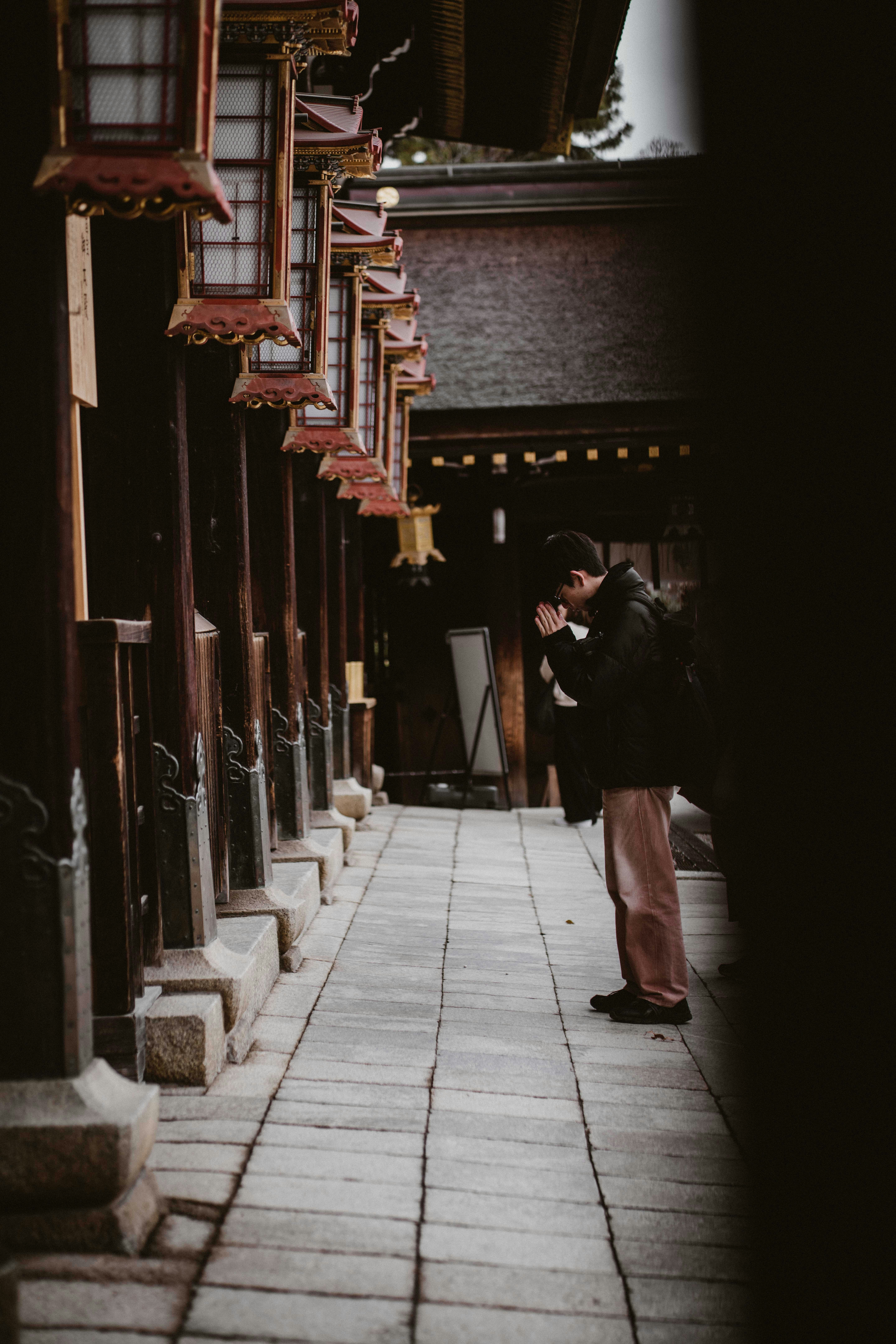Lantern-lit Reverence: A Moment Along the Temple Corridor