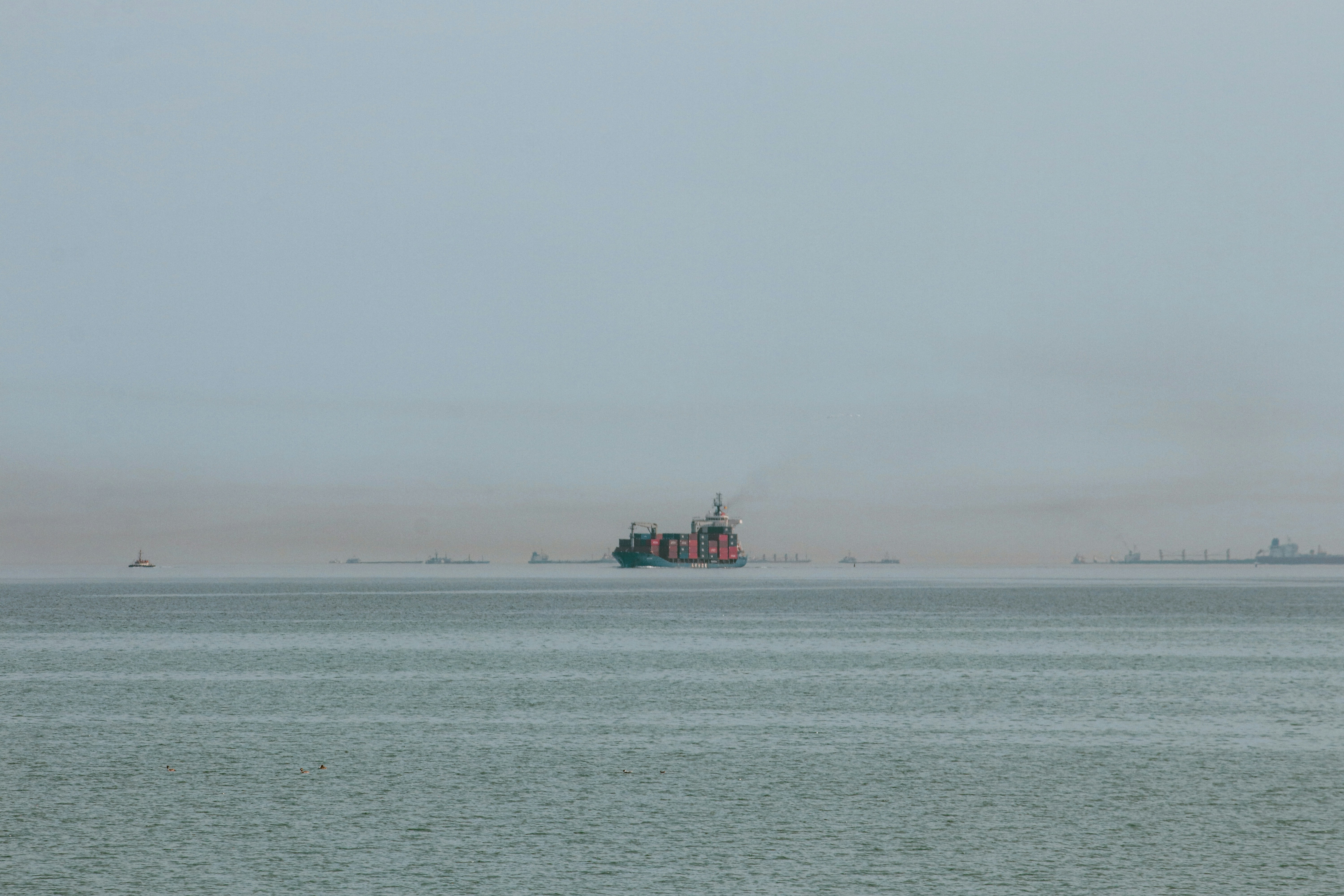 Red Tug on a Misty Horizon