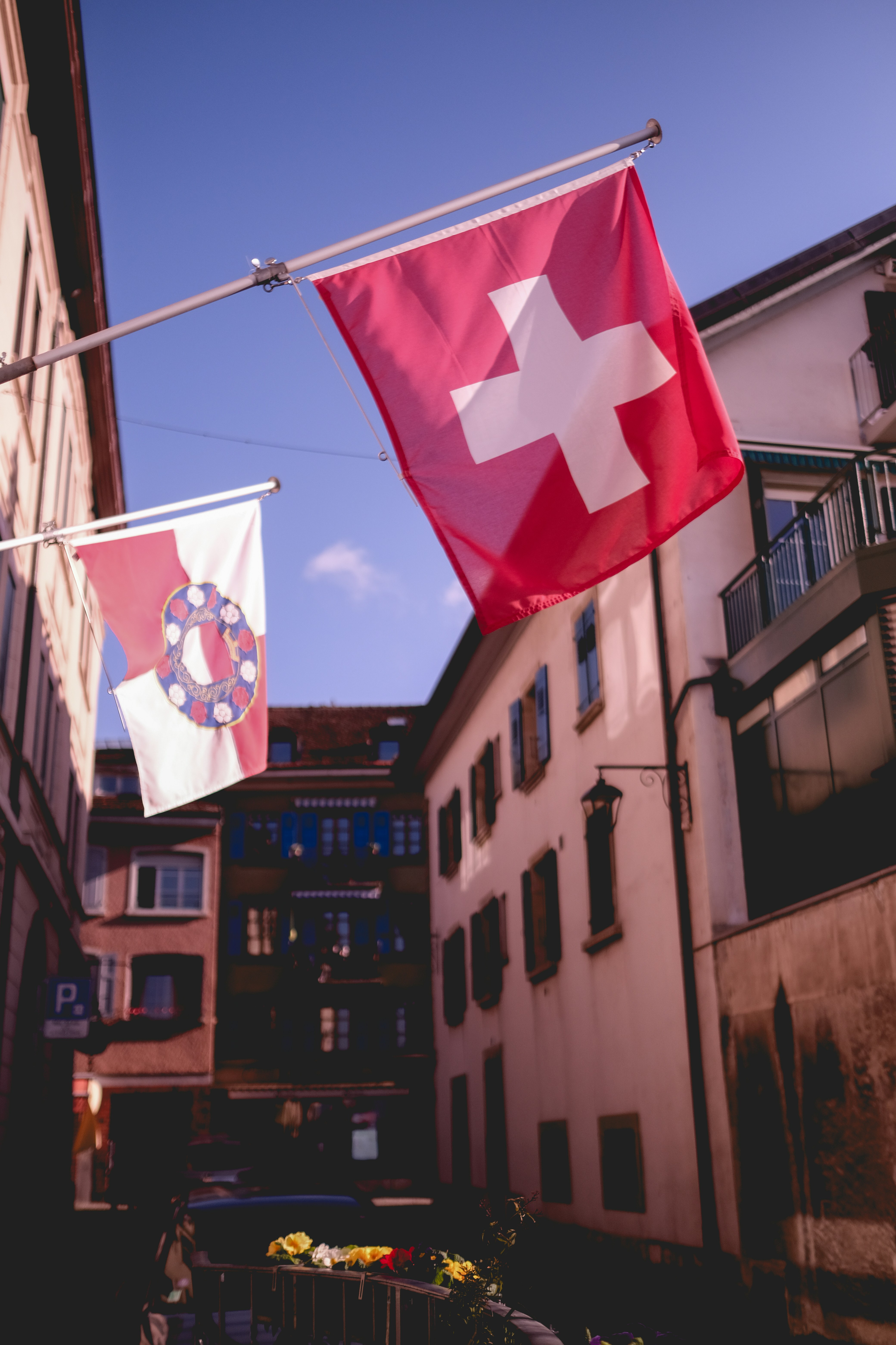 Swiss flags are waving in a european street. photo – Free Switzerland ...