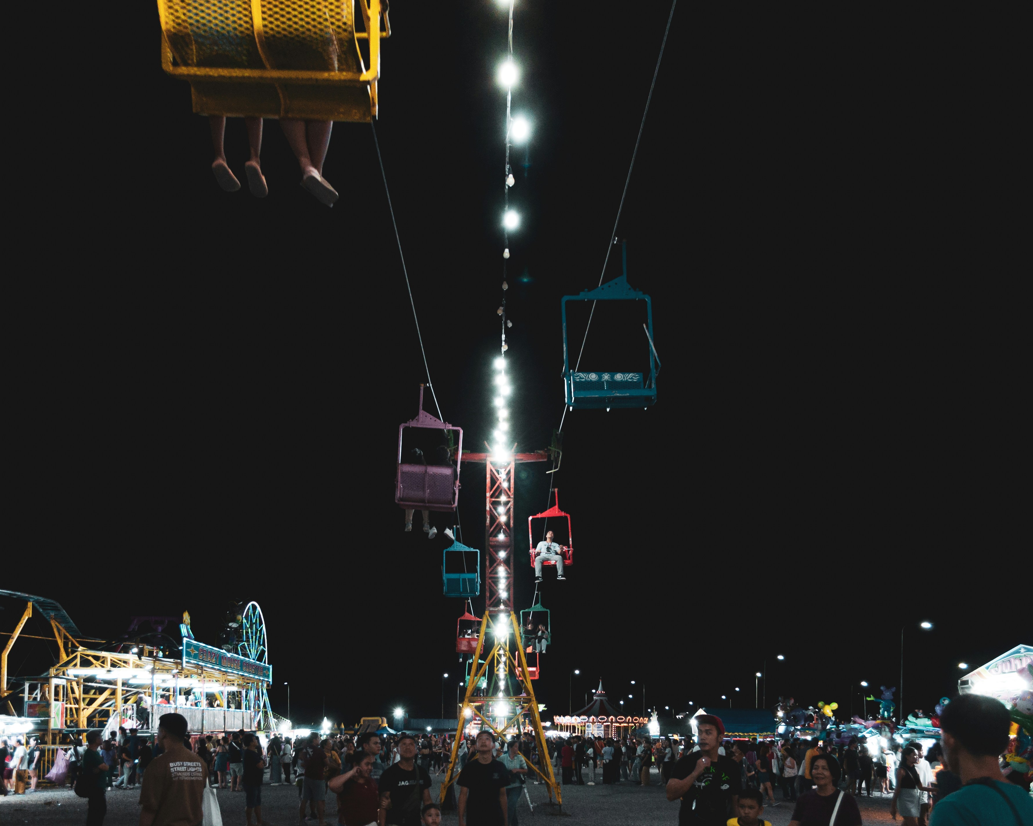 Centerline of Light: Neon Chairlift Over a Moonlit Fair