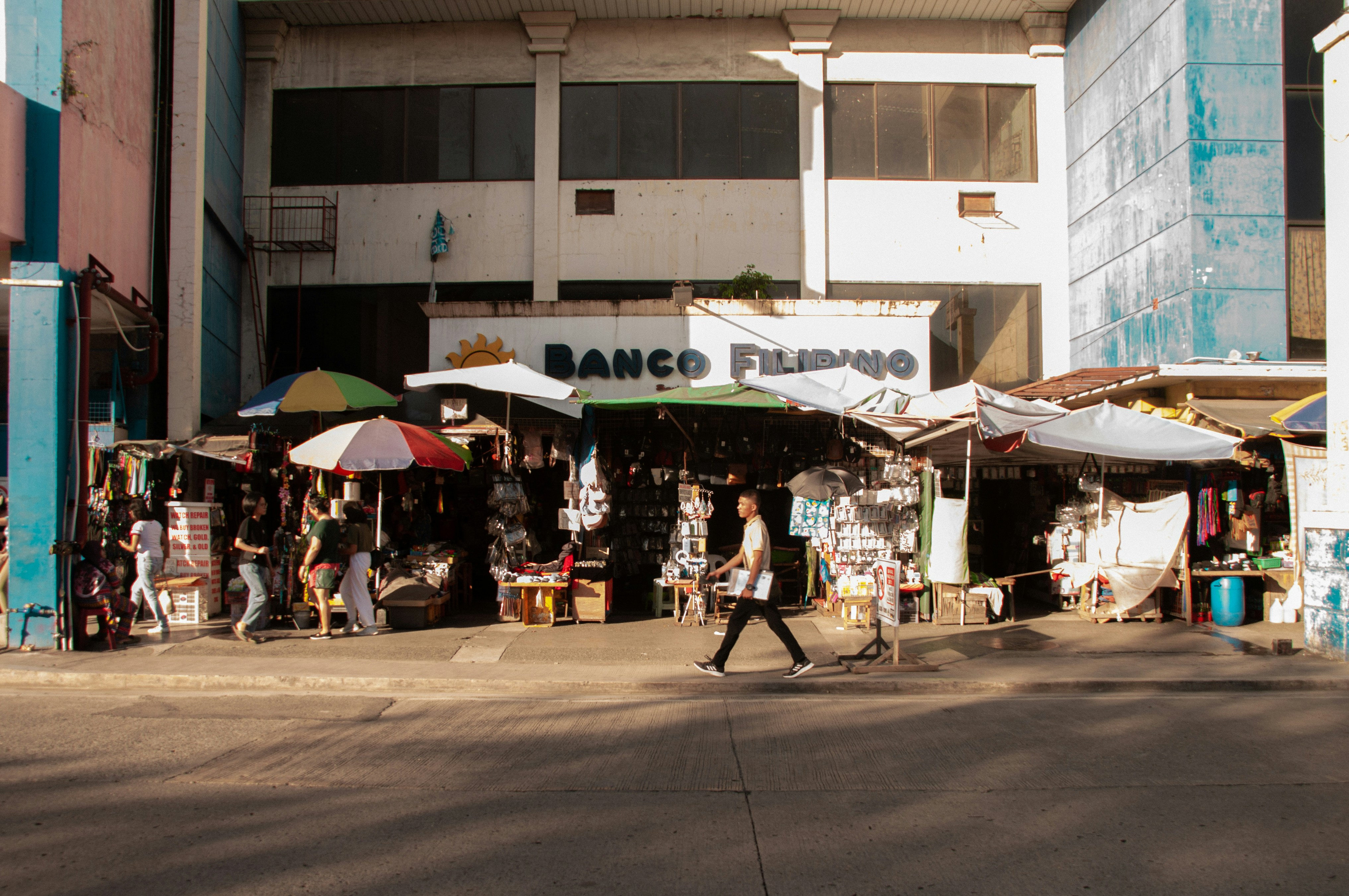 People walk past a banco filipino and street vendors. photo – Free ...