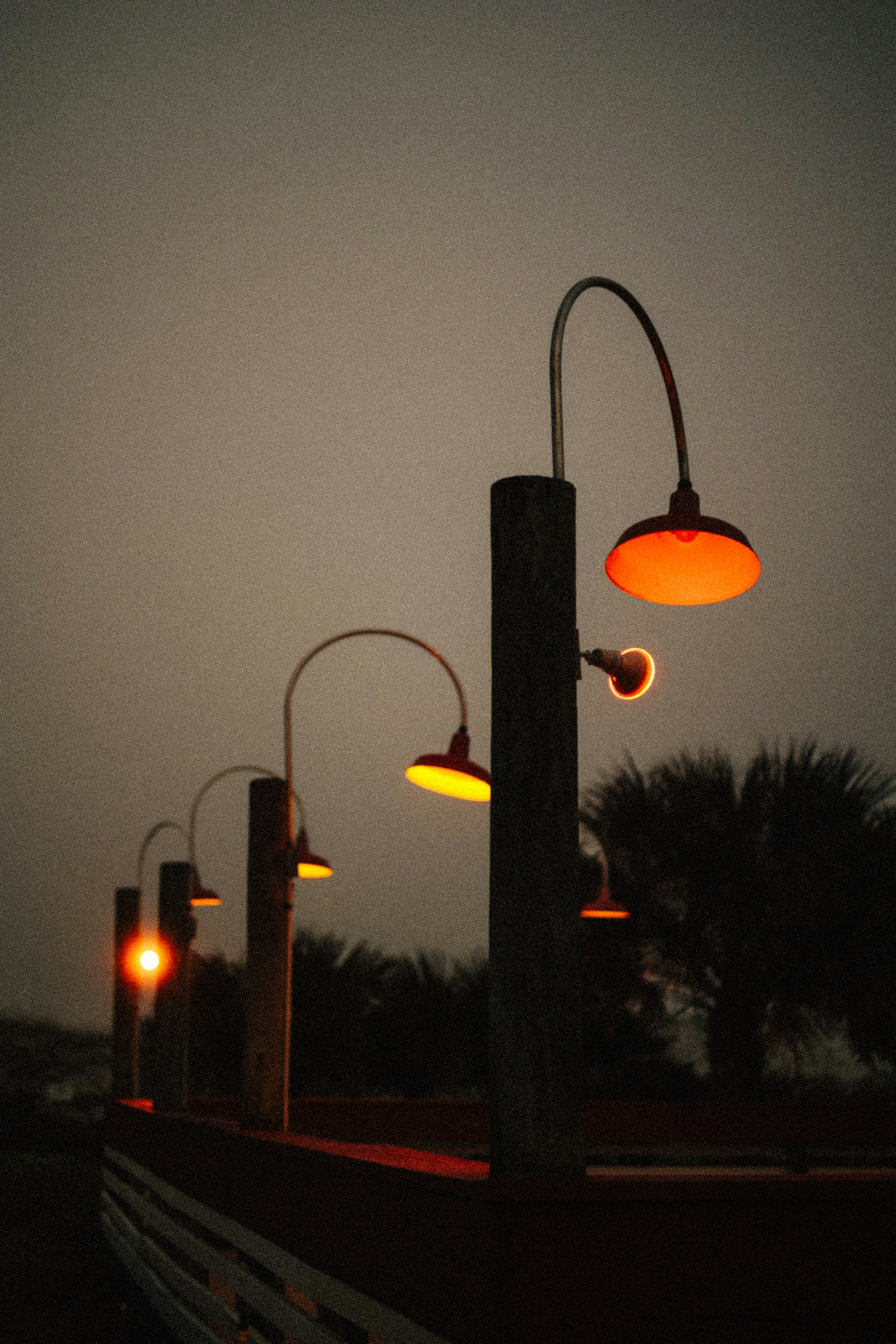 Amber-Glow Lampposts Line a Quiet Night Pier