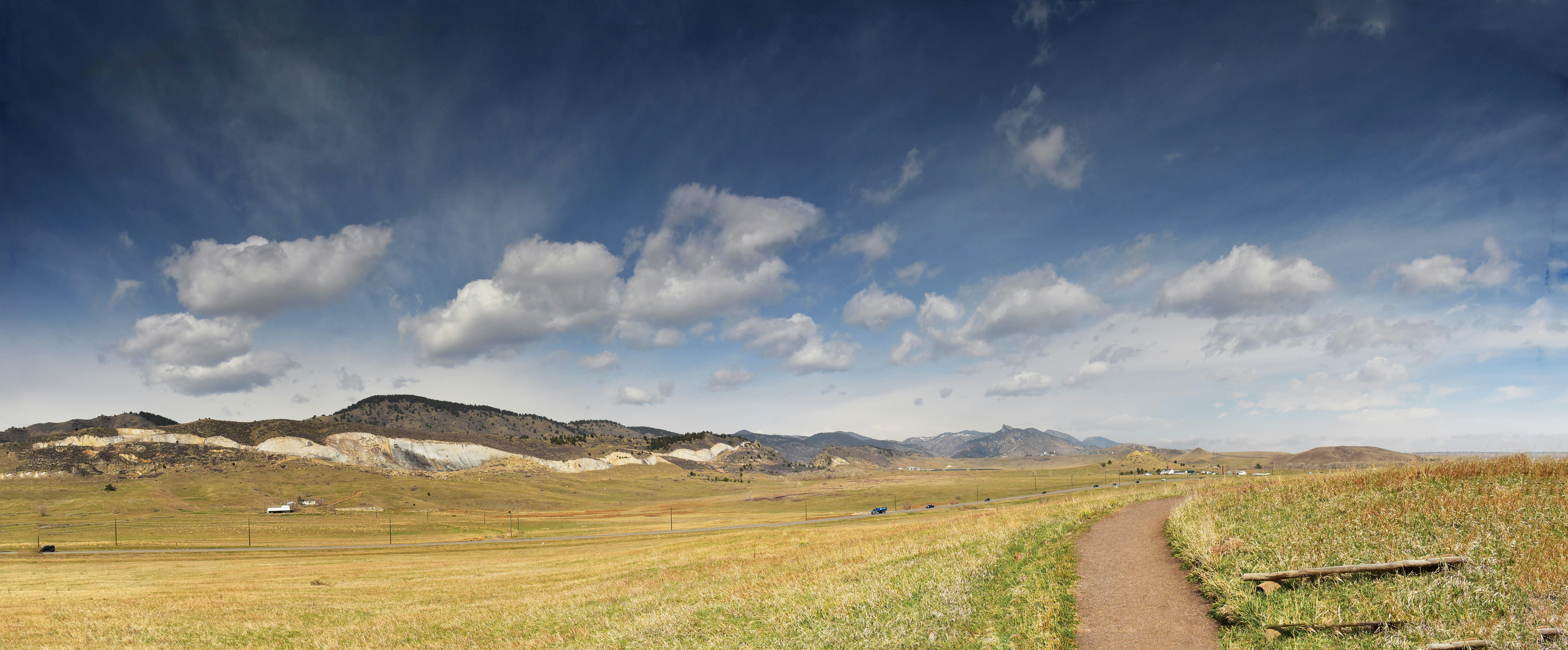 A grassy landscape with a path and mountains. photo – Free Scenery ...