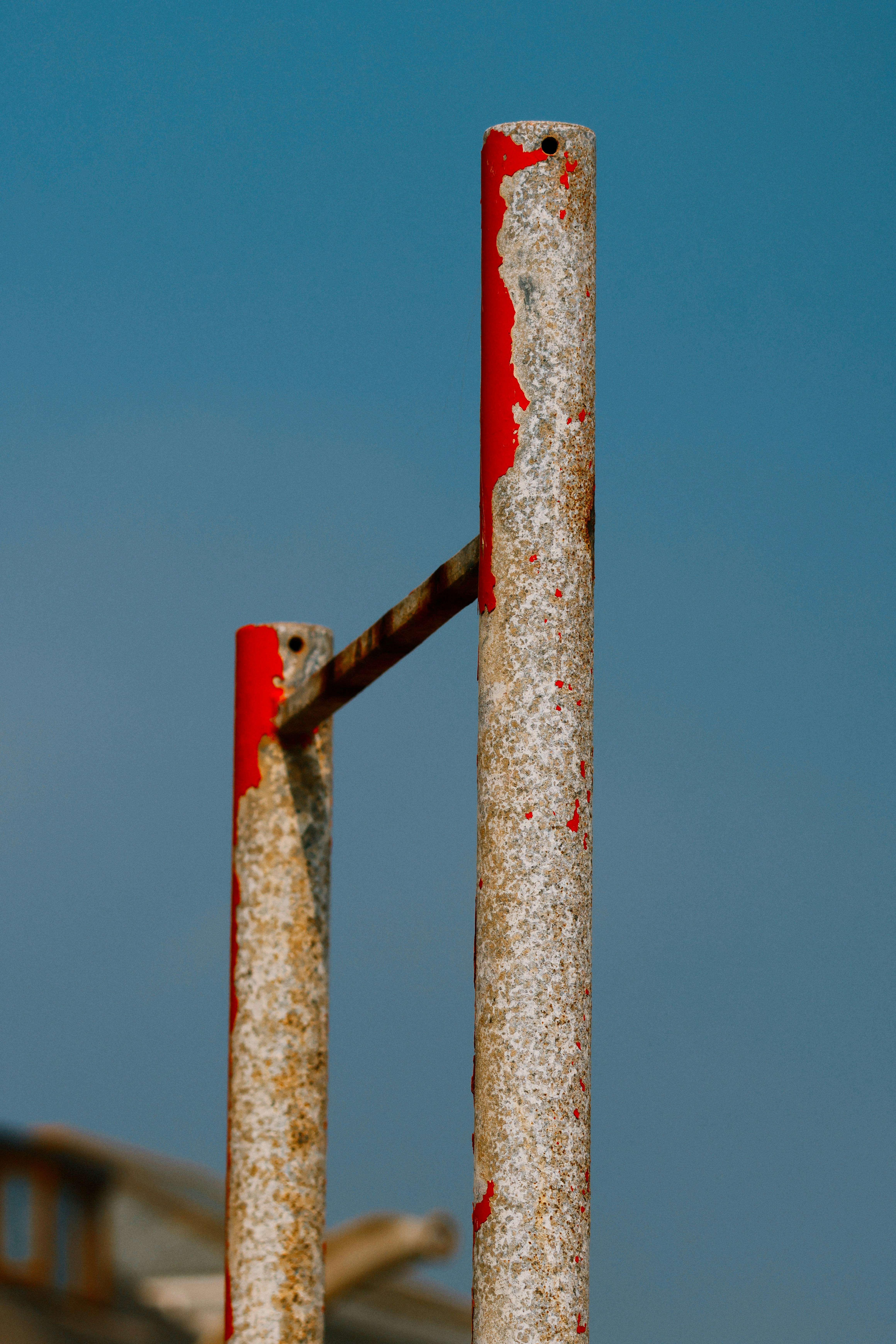 Red-tipped poles stand against a blue sky. photo – Free Weapon Image on ...